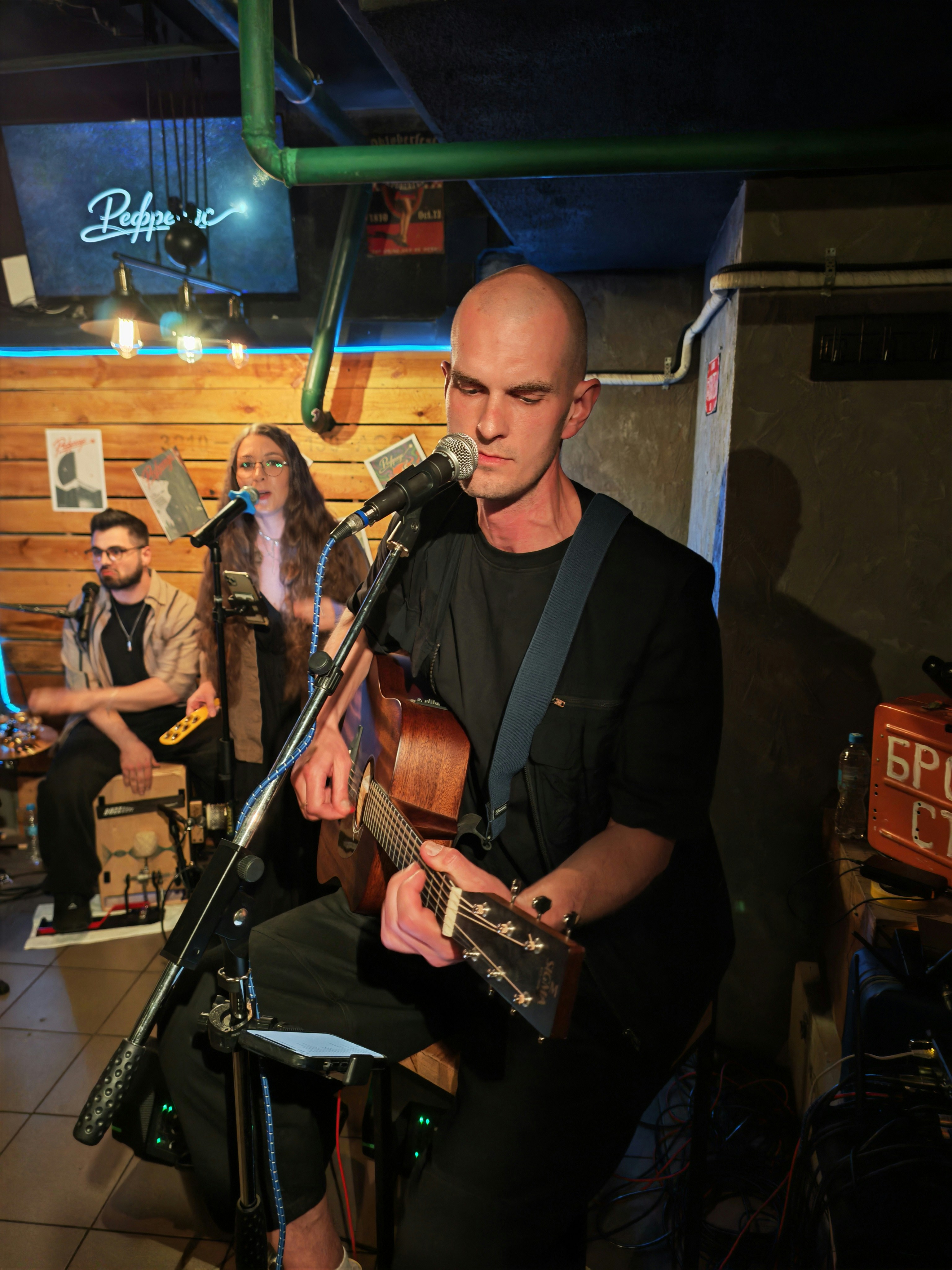 Guitarist in a dim-lit loft serenades the room with a soulful unplugged set