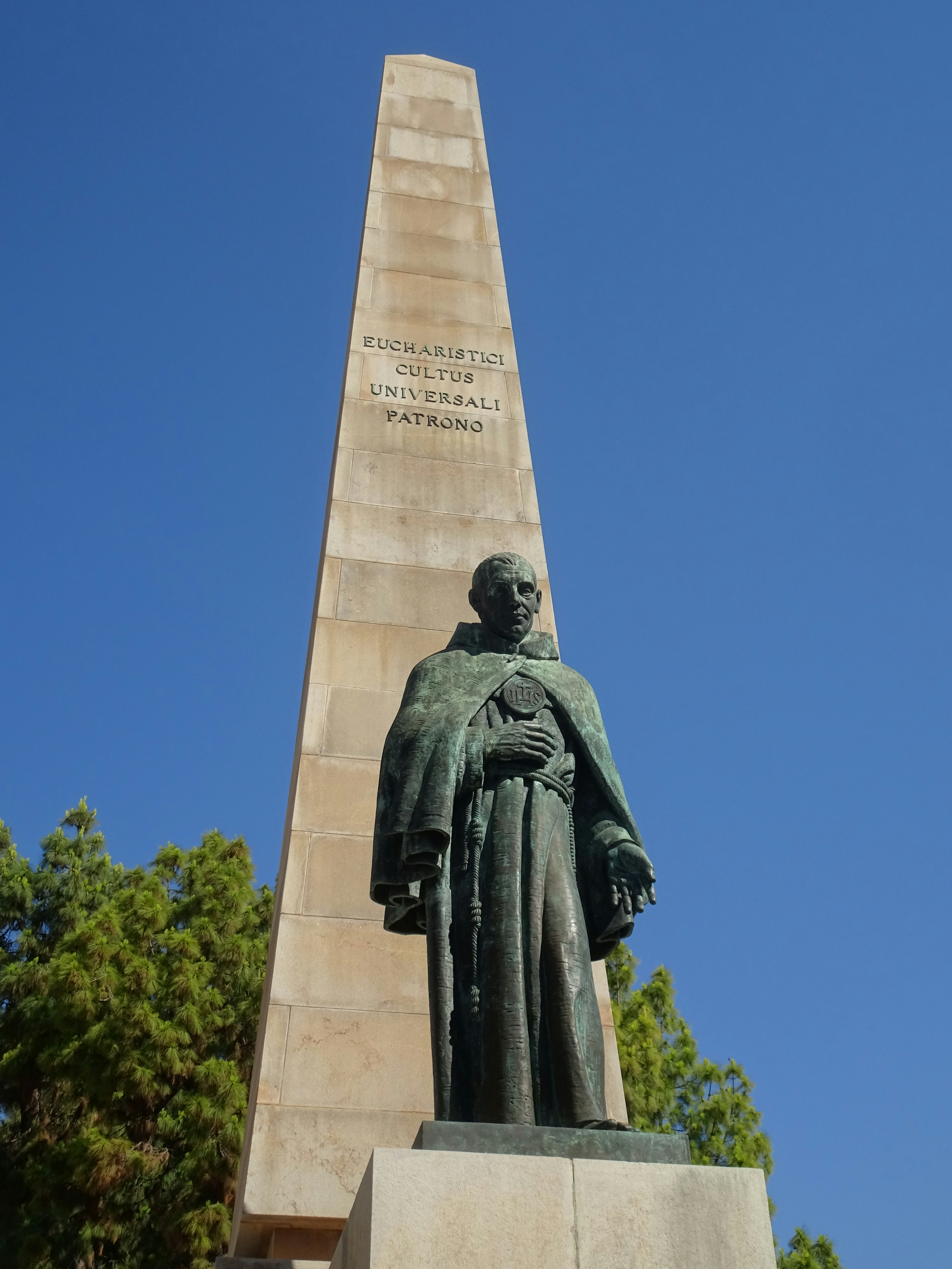 Monumental Barber of Philosophy: A Bronze Figure Guarding a Marble Obelisk