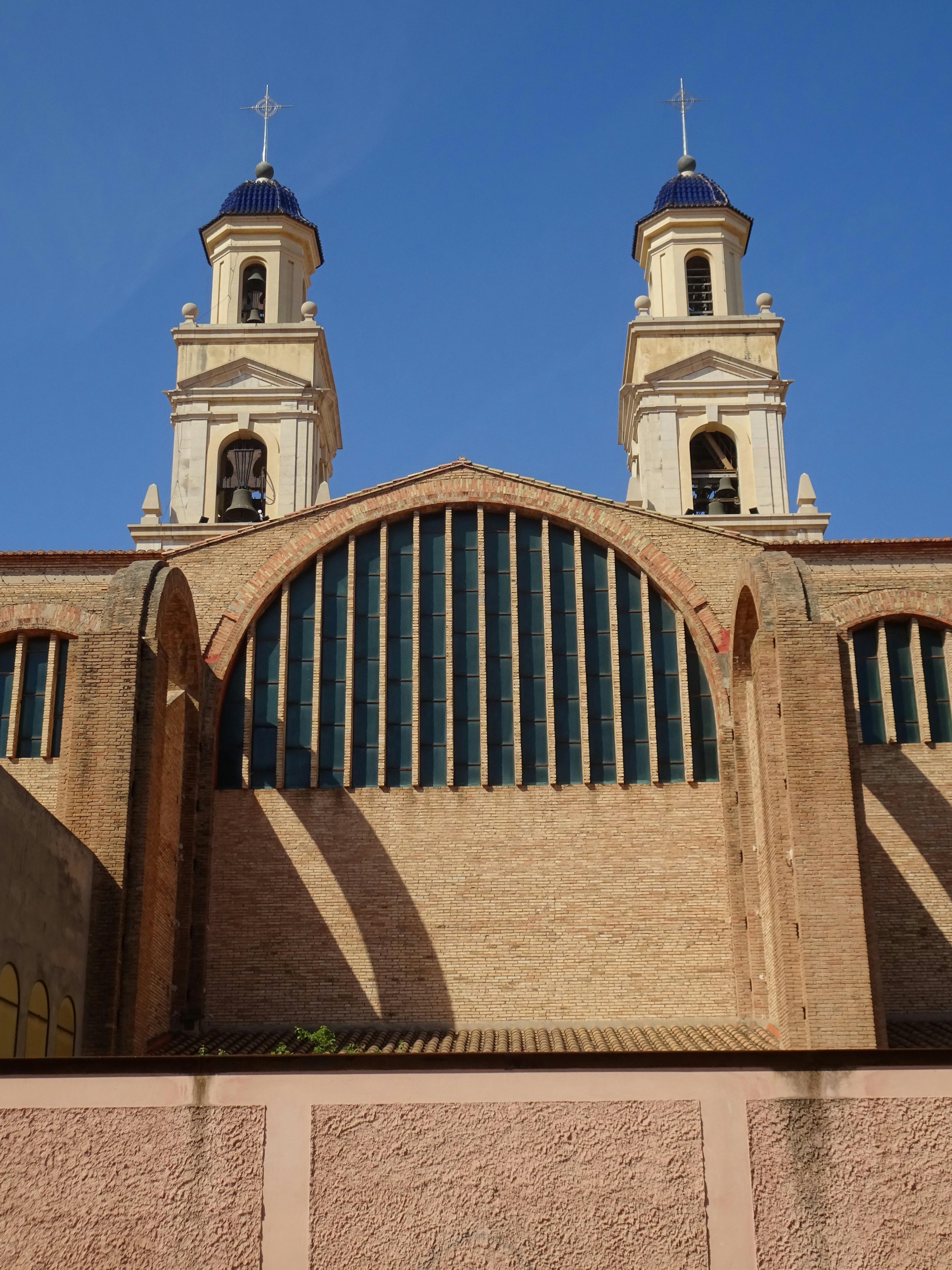 Twin Bell Towers Rise Over a Brick Basilica