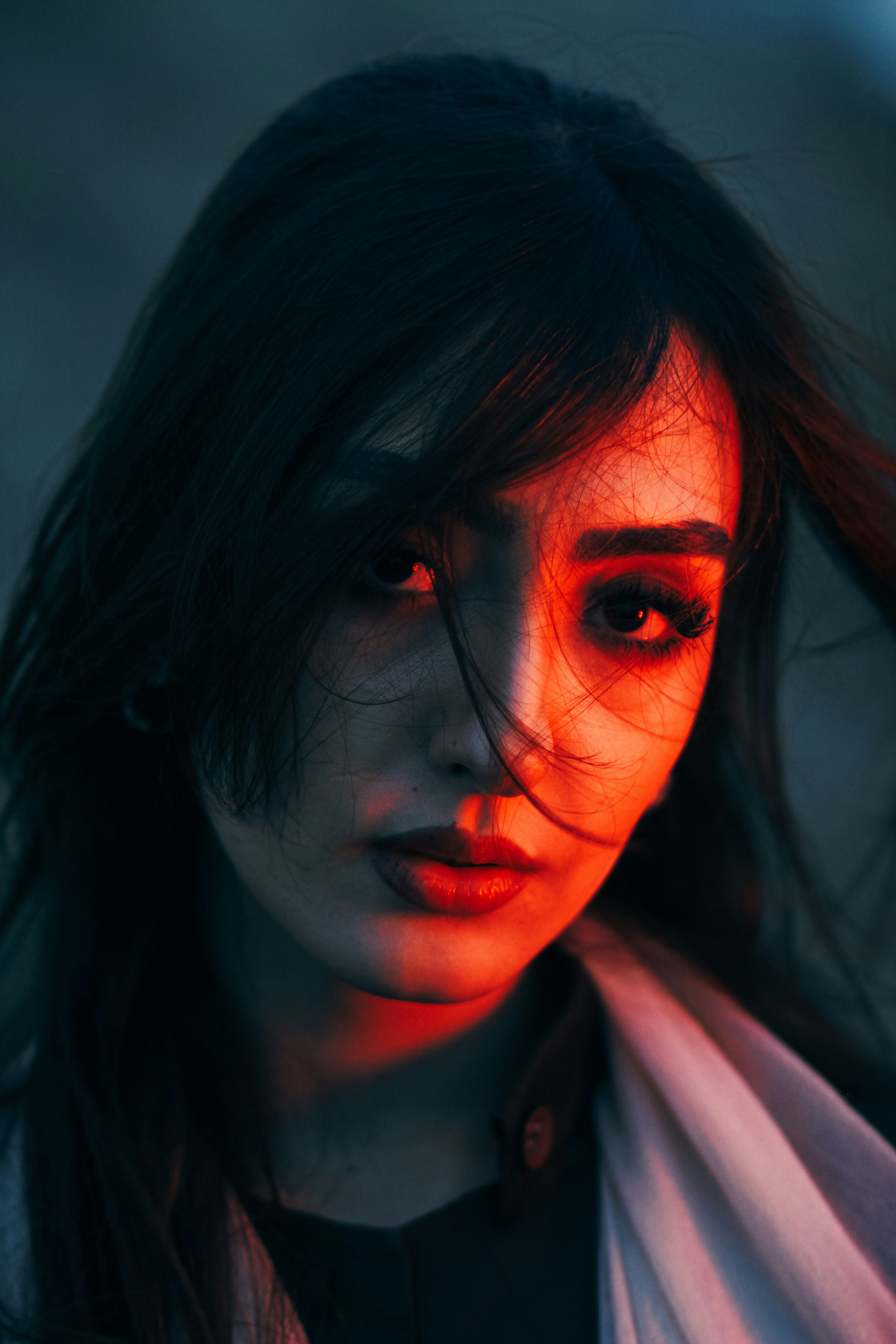 Crimson Shadow: A Portrait Bathed in Dual Light