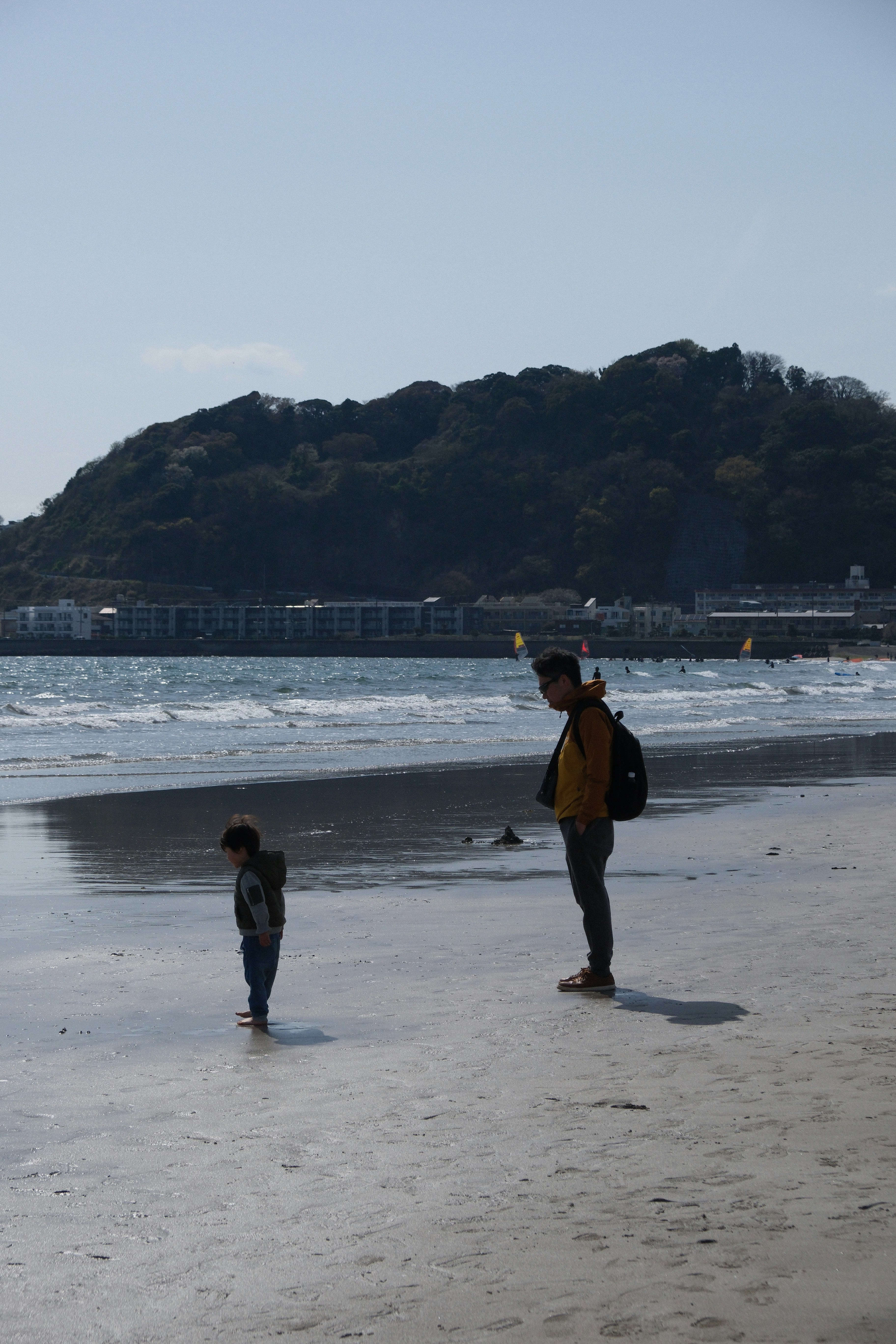 Lines of Shoreline: A Quiet Beach Moment with a Watching Figure