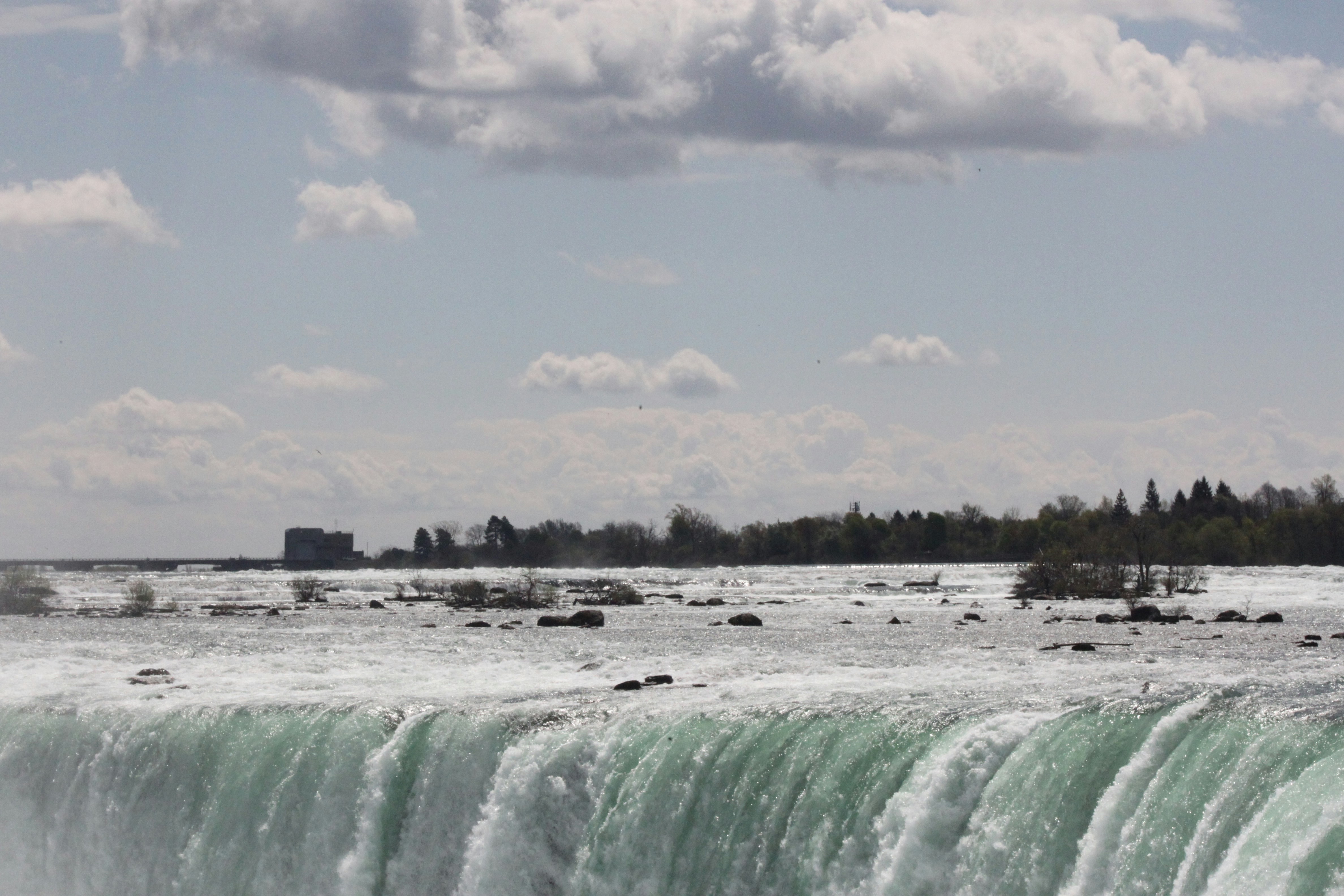 Cascading cityline at the edge of a sunlit waterfall