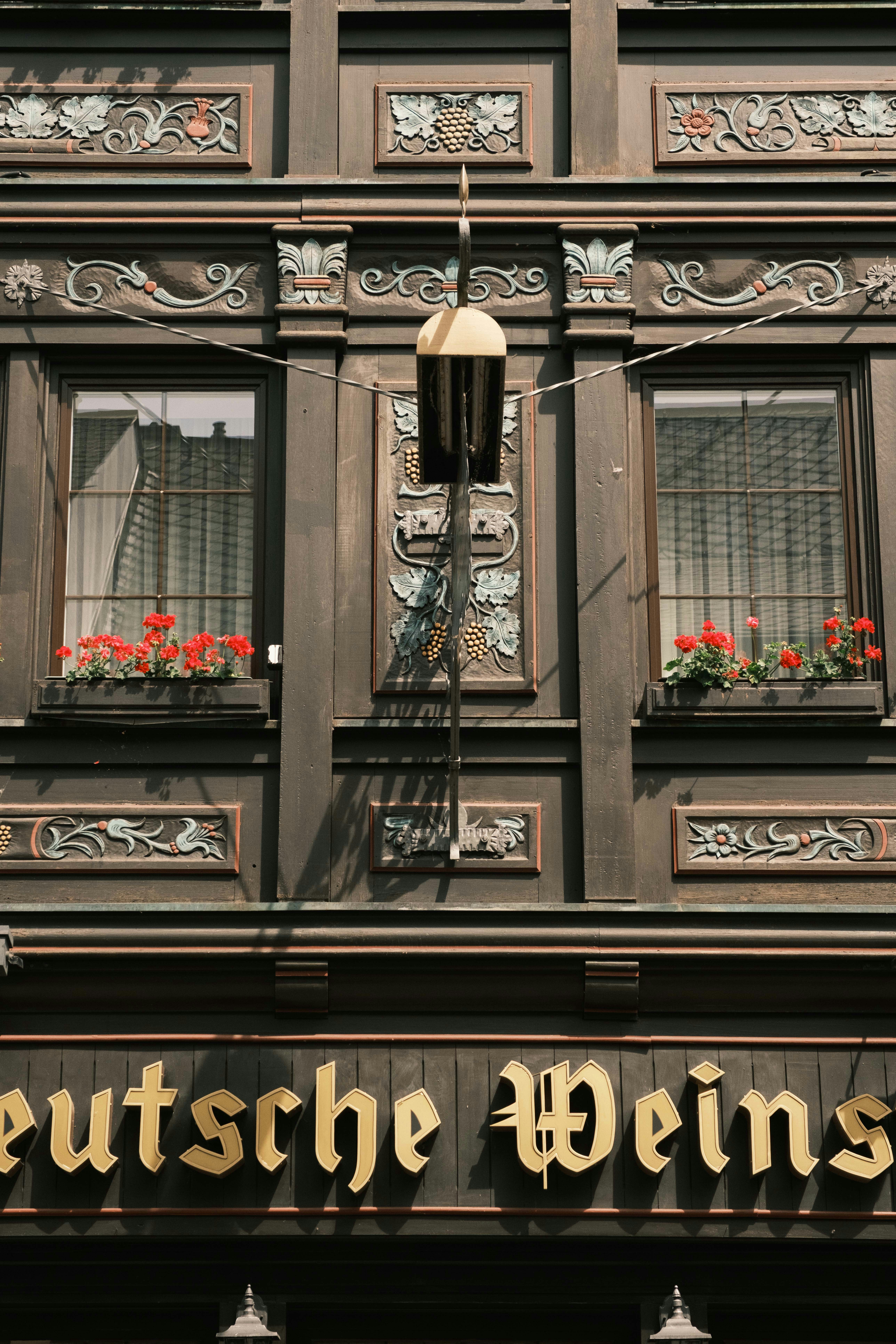 Ornate Facade with Central Wind Chime and Flower Boxes