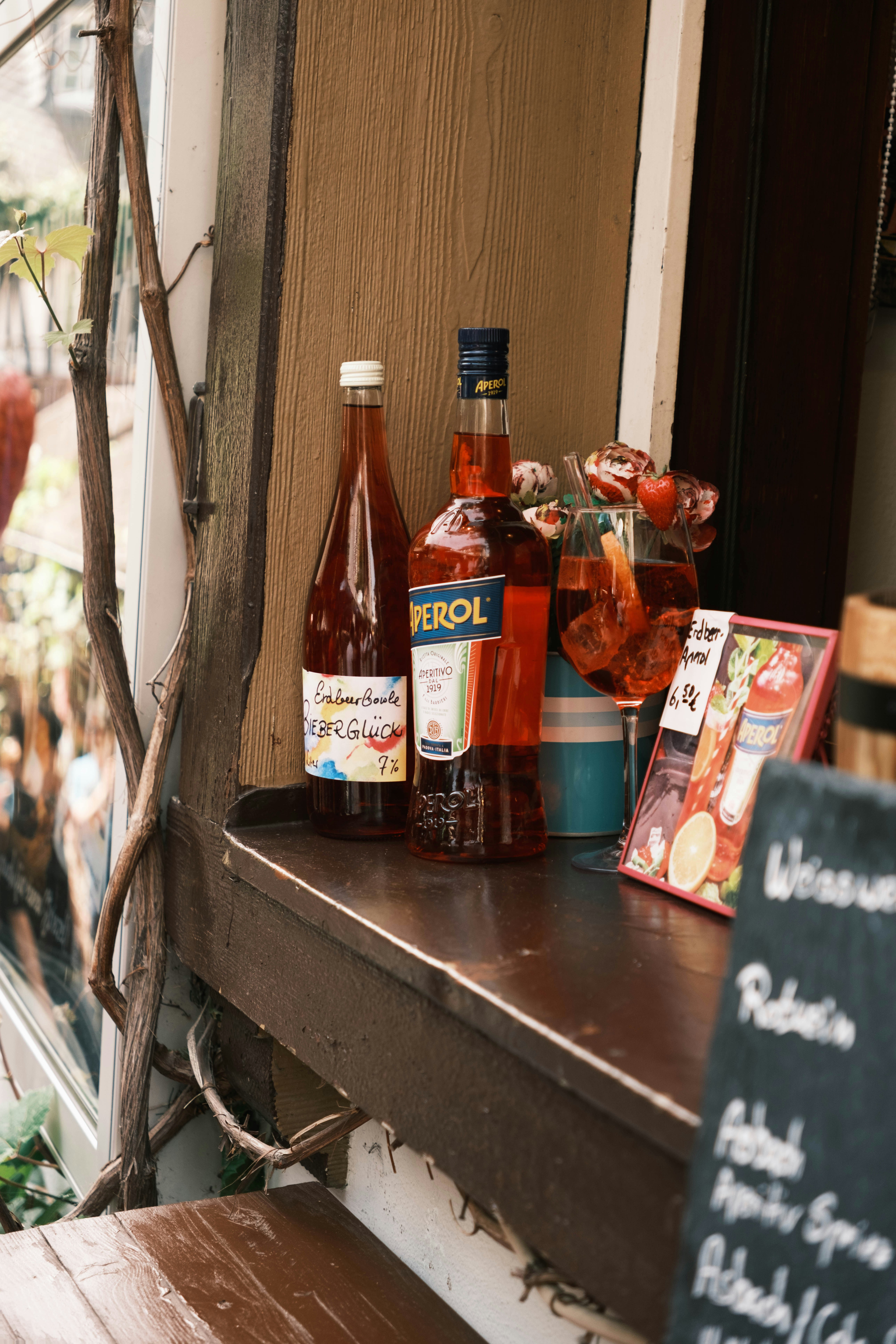 Bottle lineup by the window: a warm still life with citrus glow