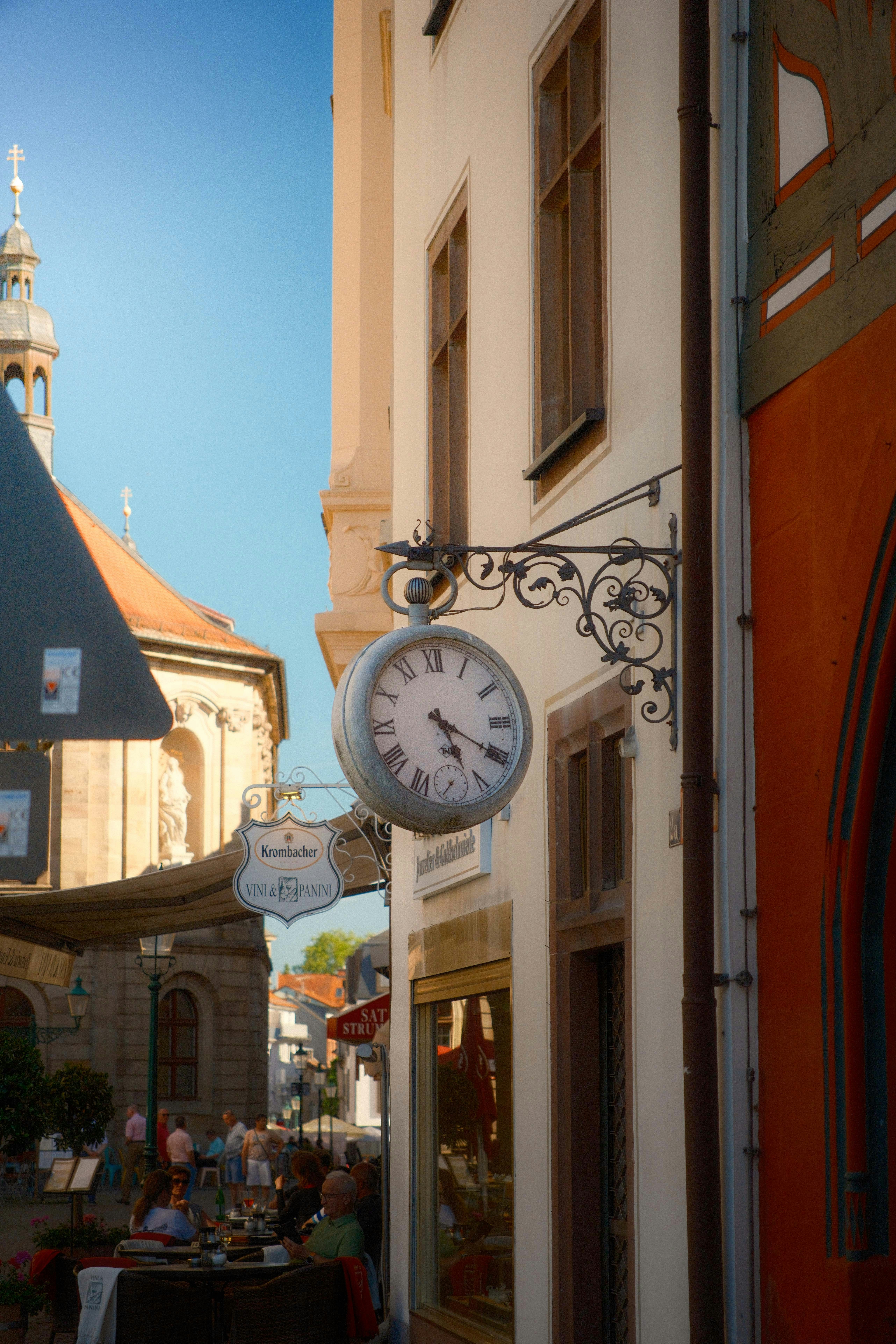 Clock Over Cobblestones: A Sunlit Street in Vintage Hue