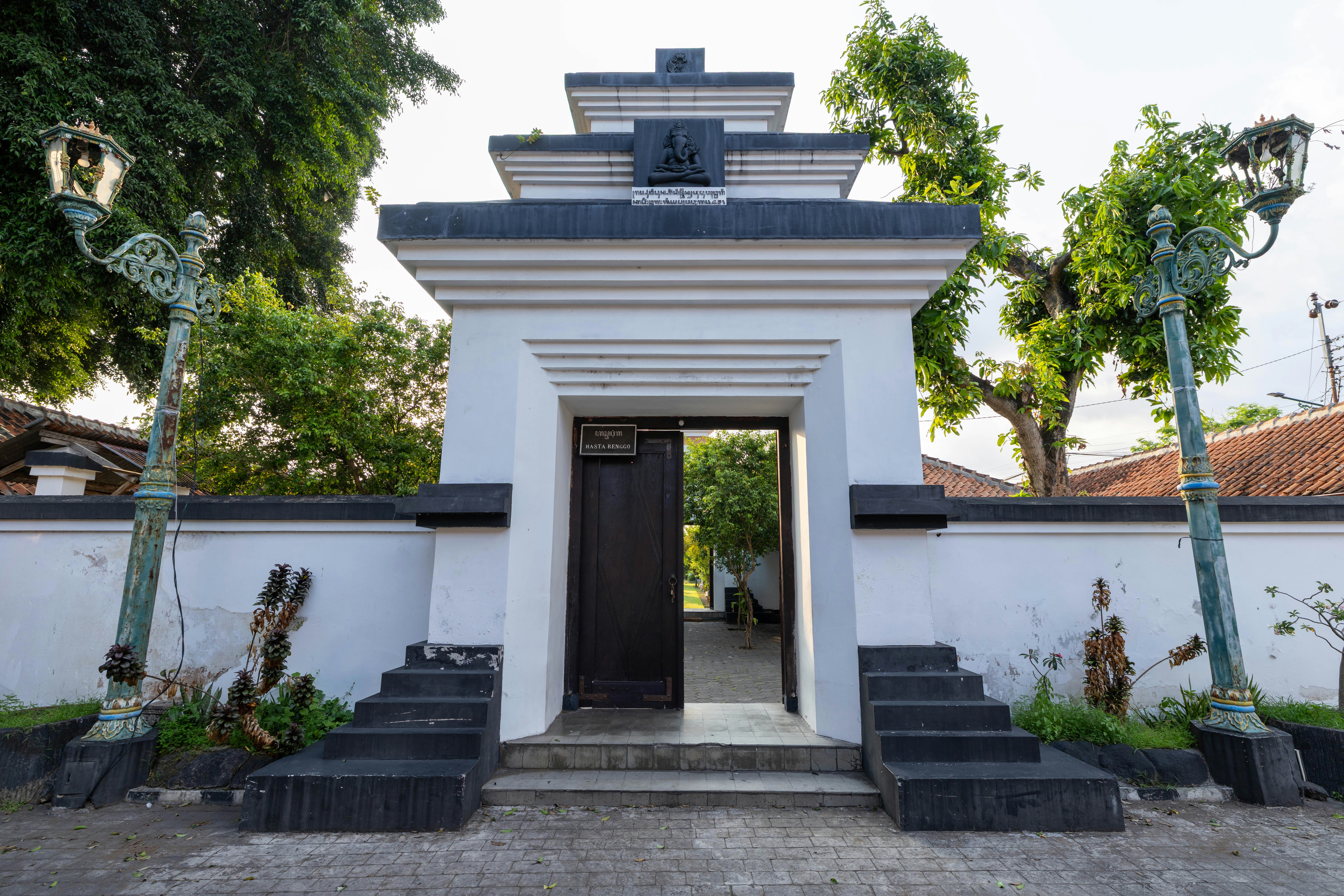 Gateway to tradition: central archway framed by palms