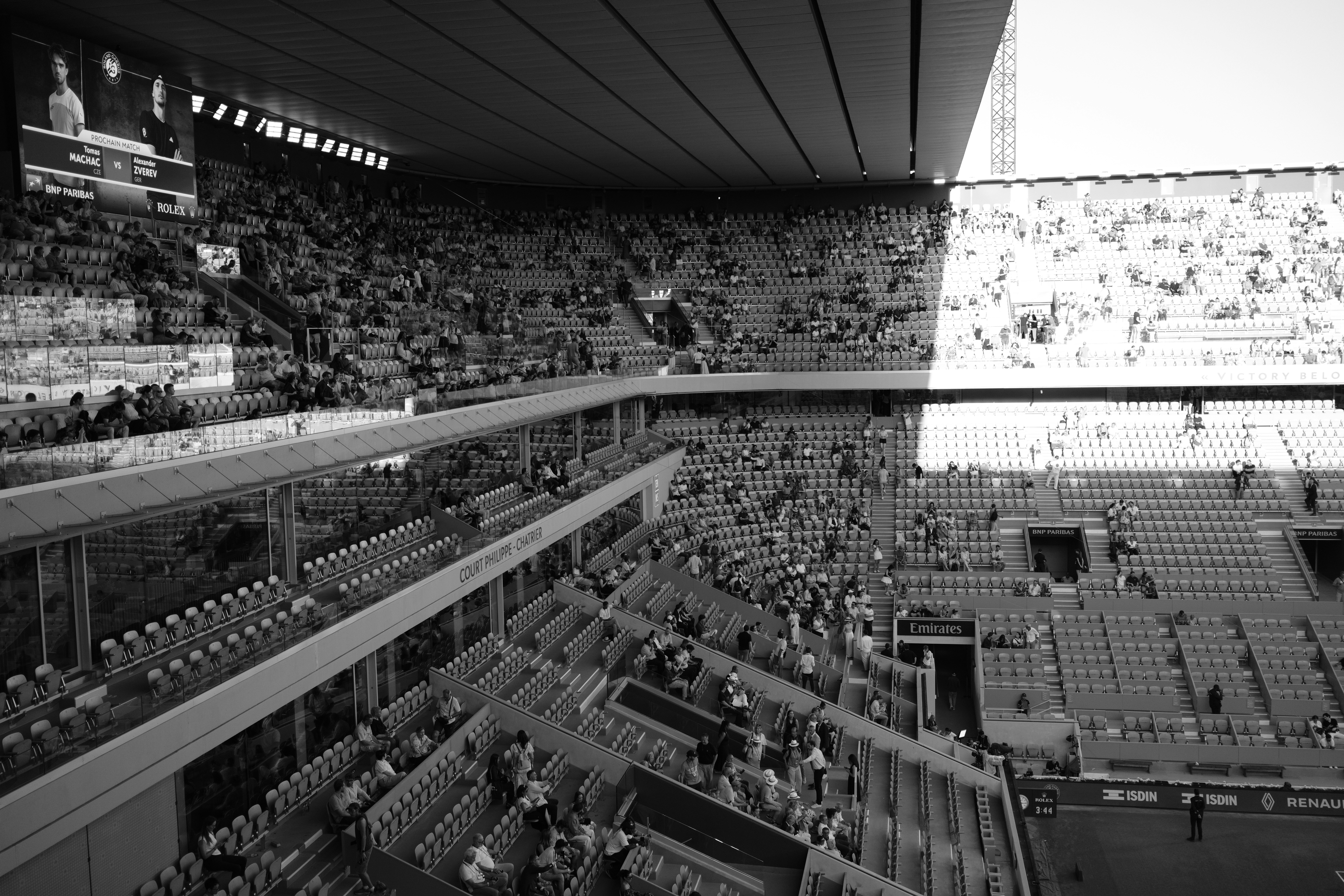 Black and white view of a stadium filled with spectators.