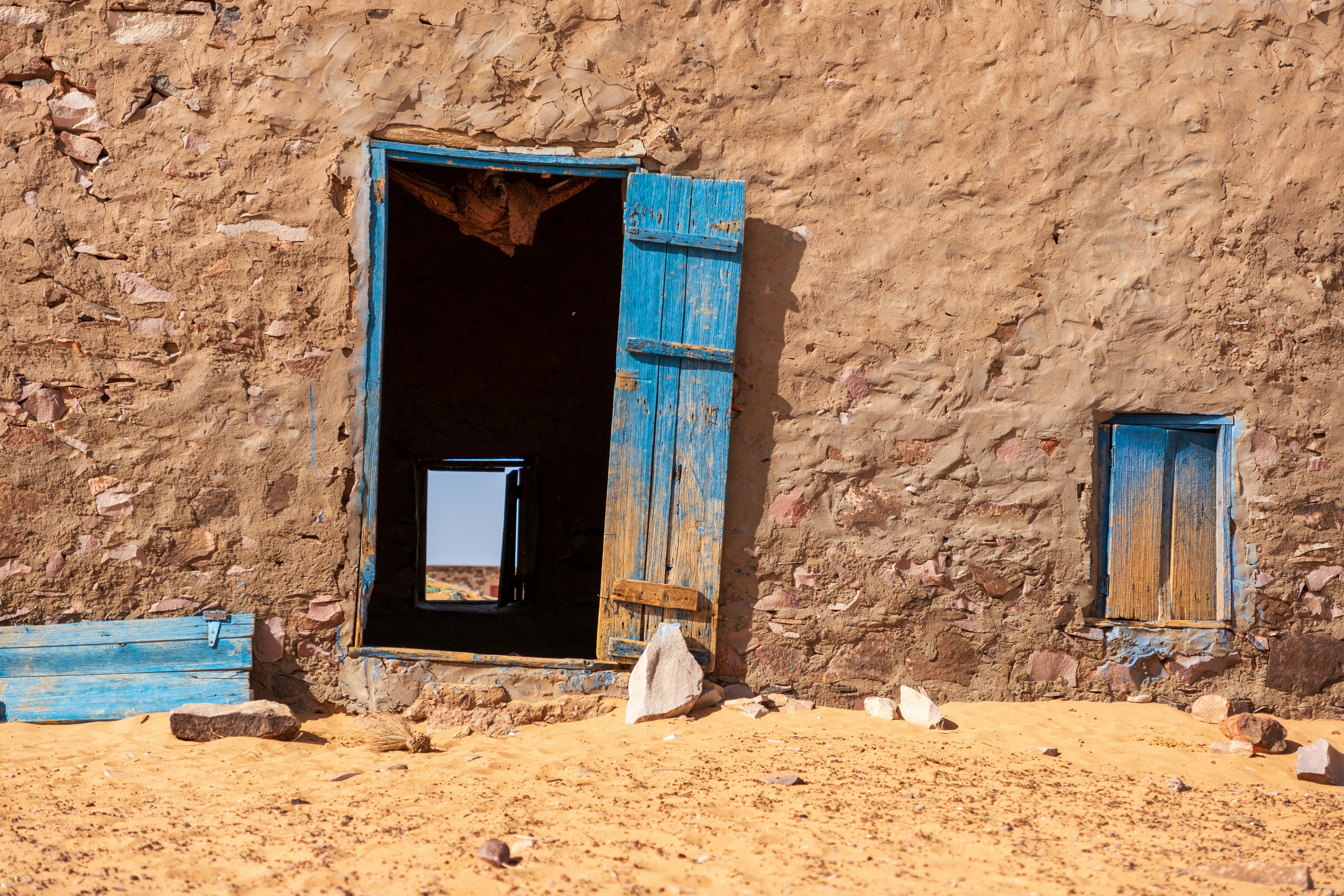 Blue Doorway in Sunlit Adobe Wall