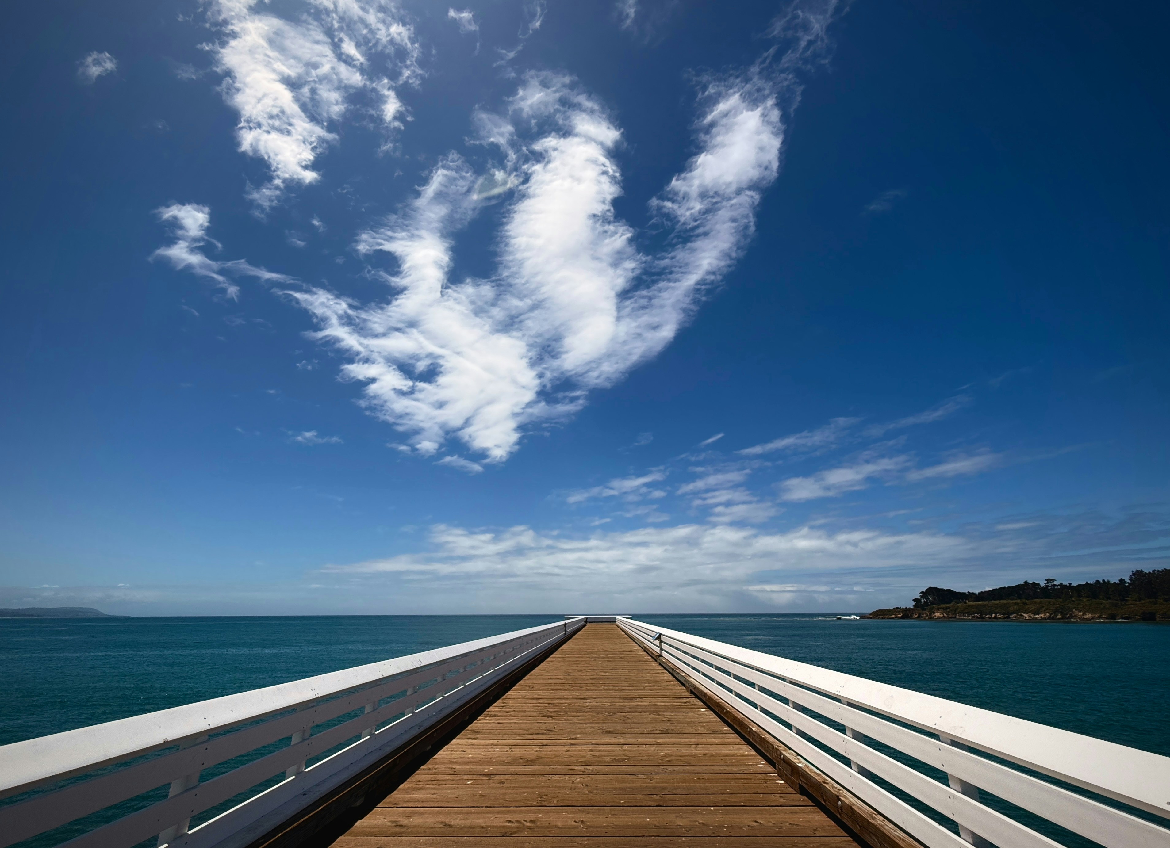 Endless Boardwalk: A Pier Reaching the Sea’s Edge