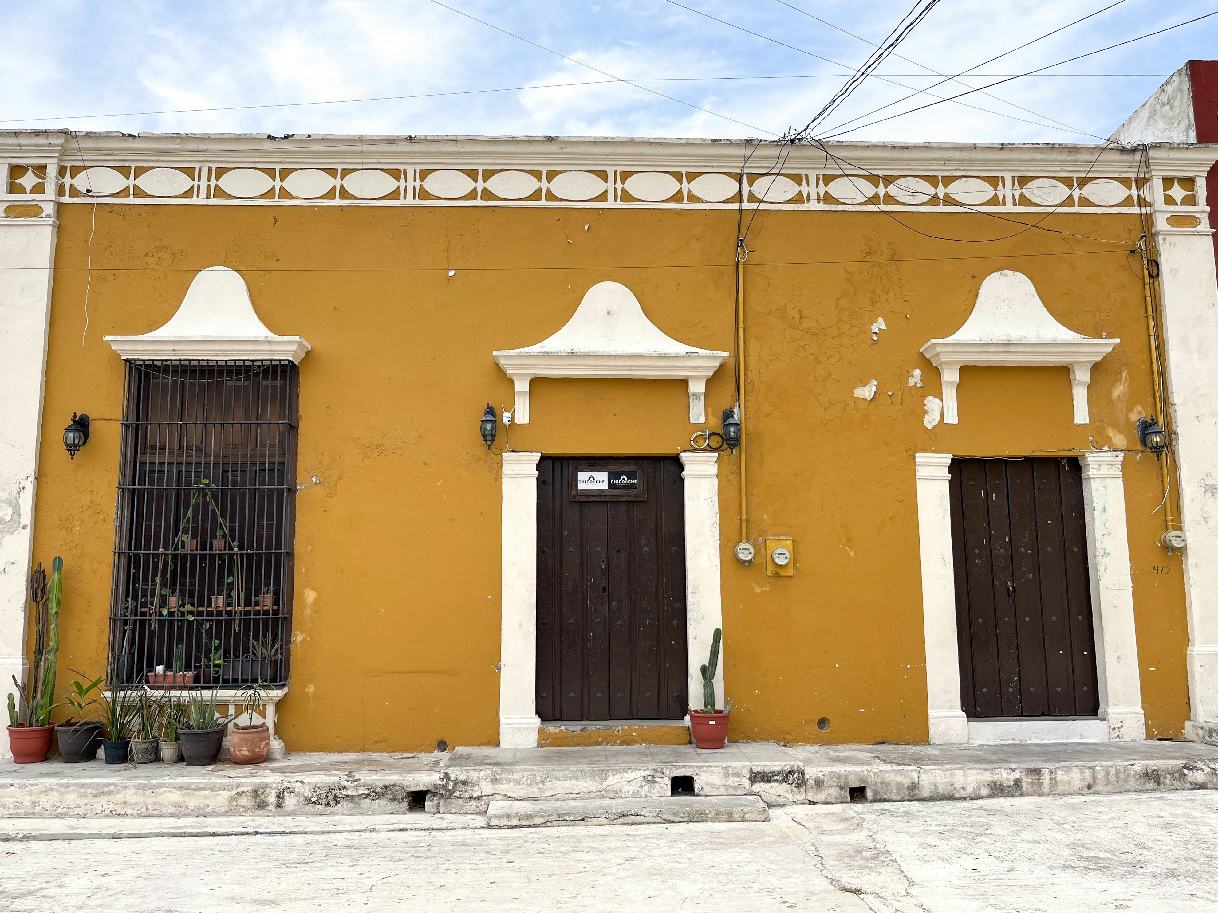 Sunlit Colonial Doorway Row on Warm Ochre Facade