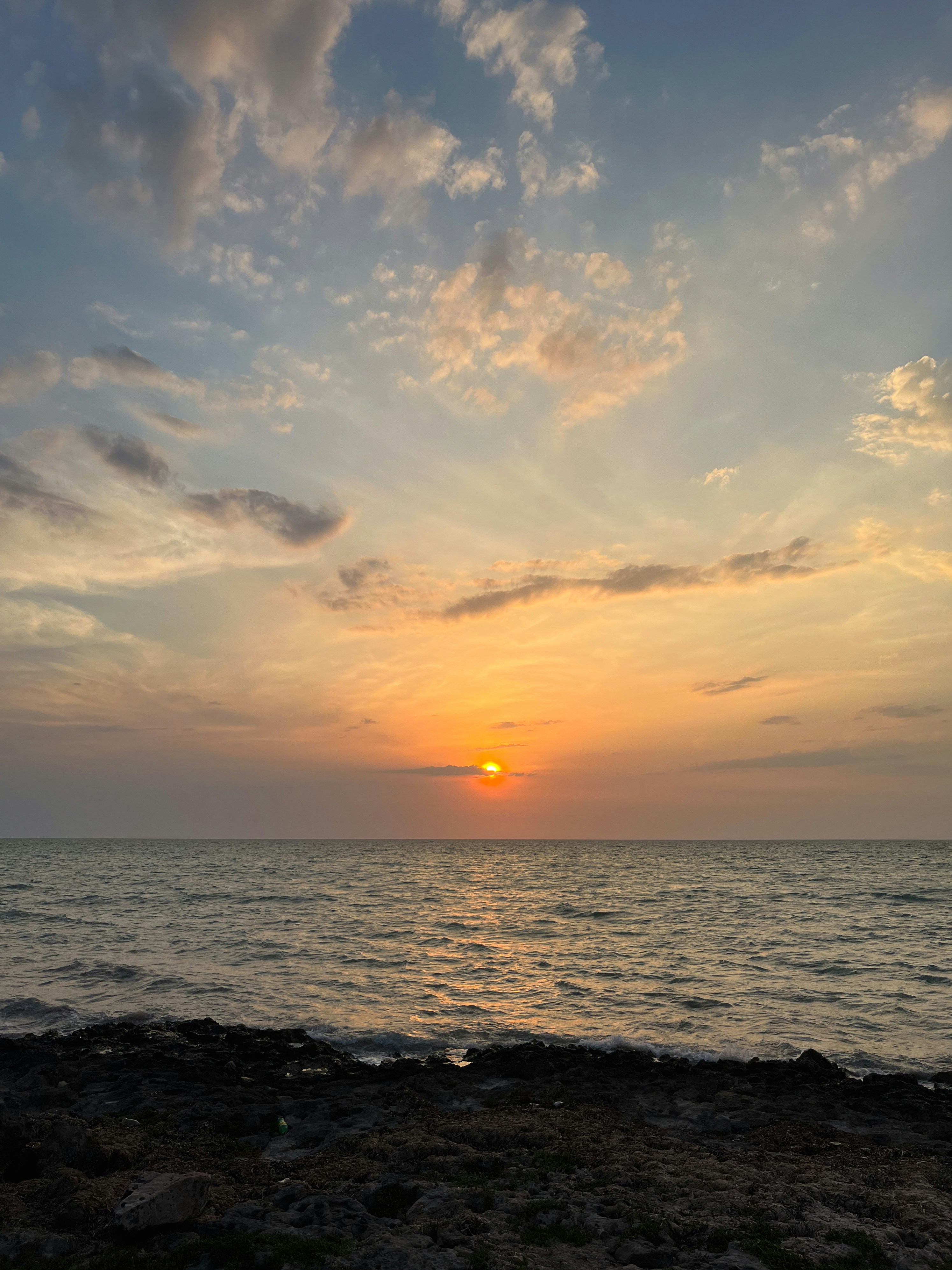 Sunlit Horizon: Quiet Sea at Dusk