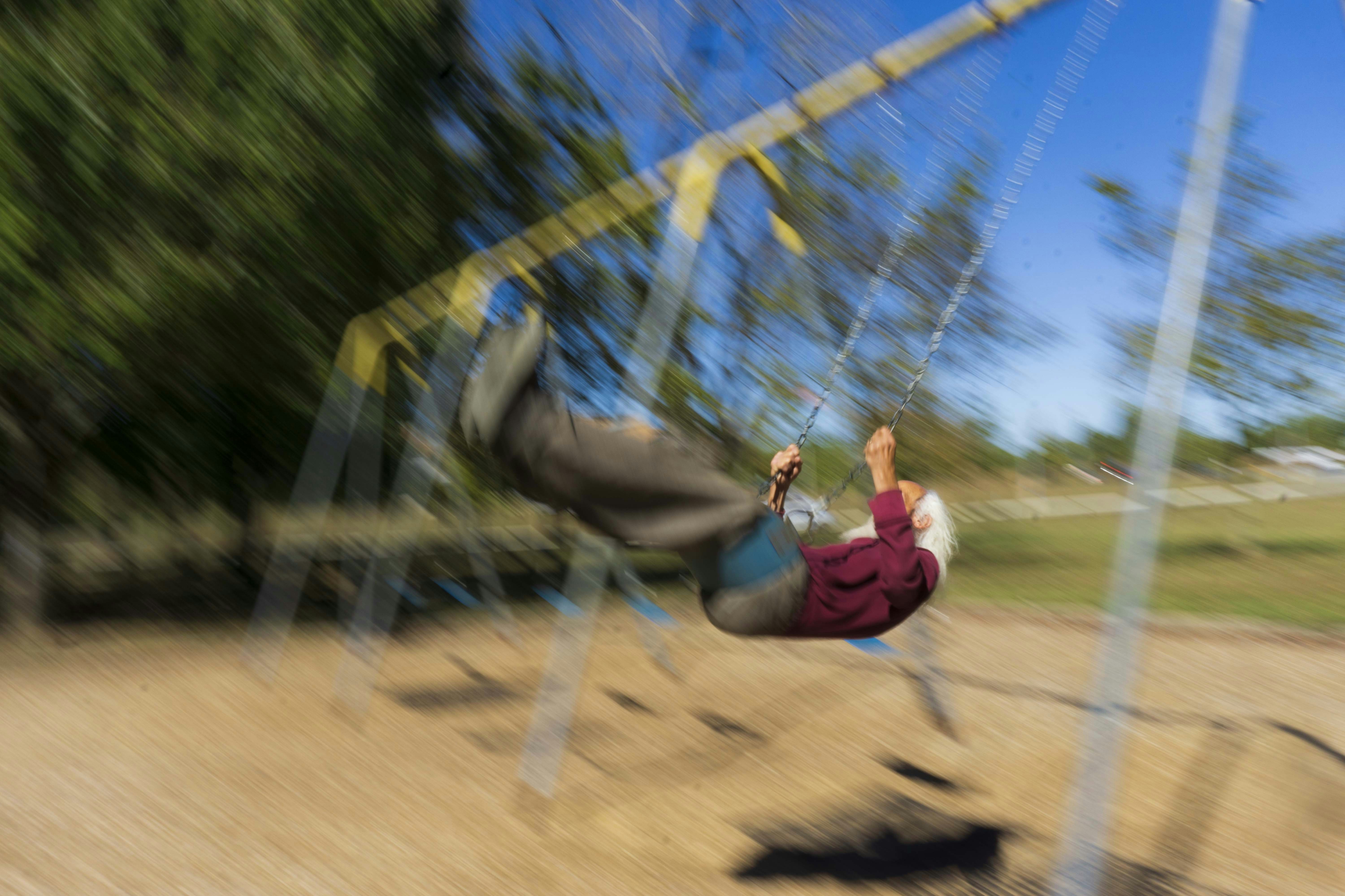 Swinging through motion blur: a child on a swing caught mid-air