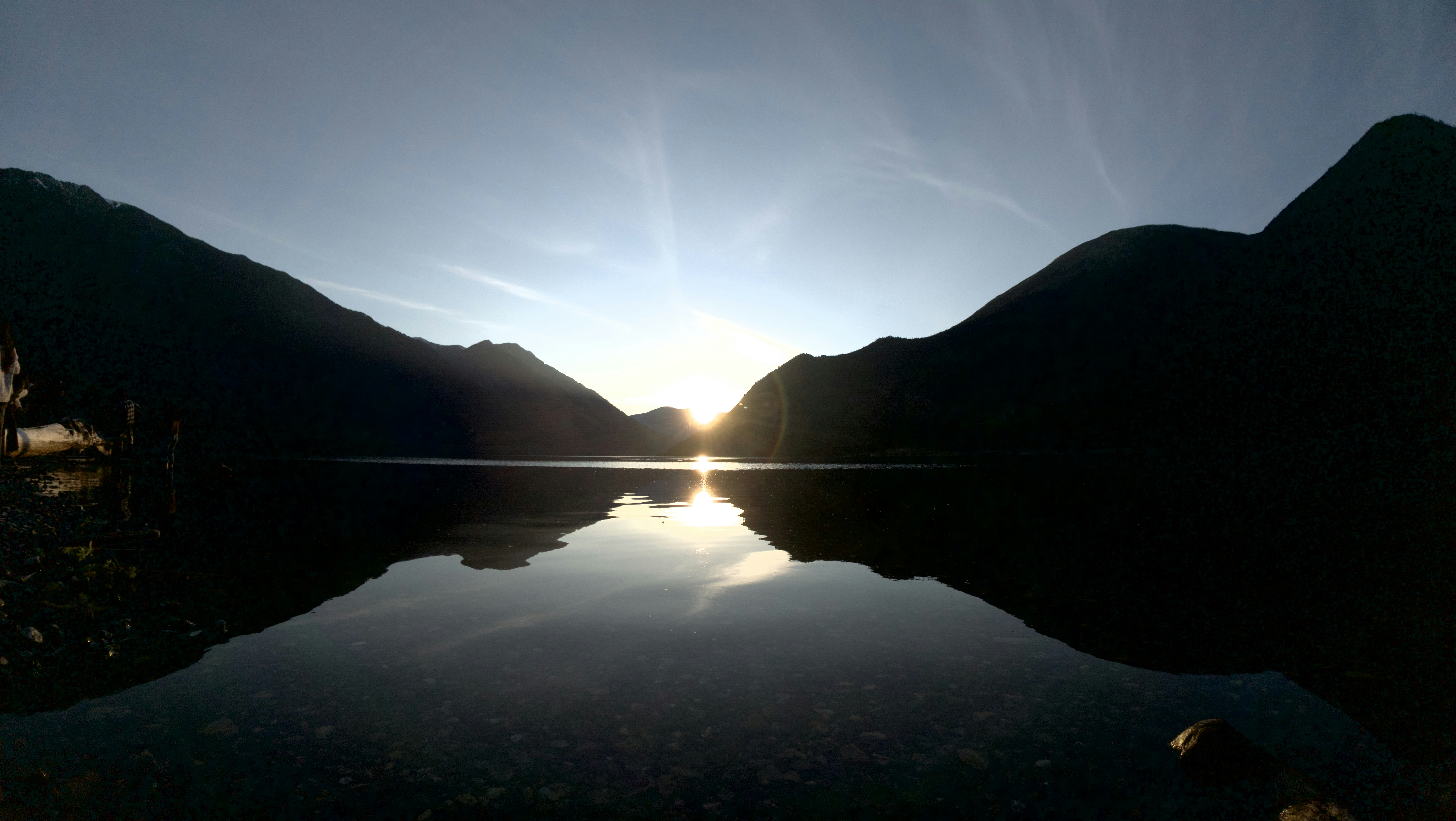 Sunrise Between Quiet Peaks Over a Glassy Lake