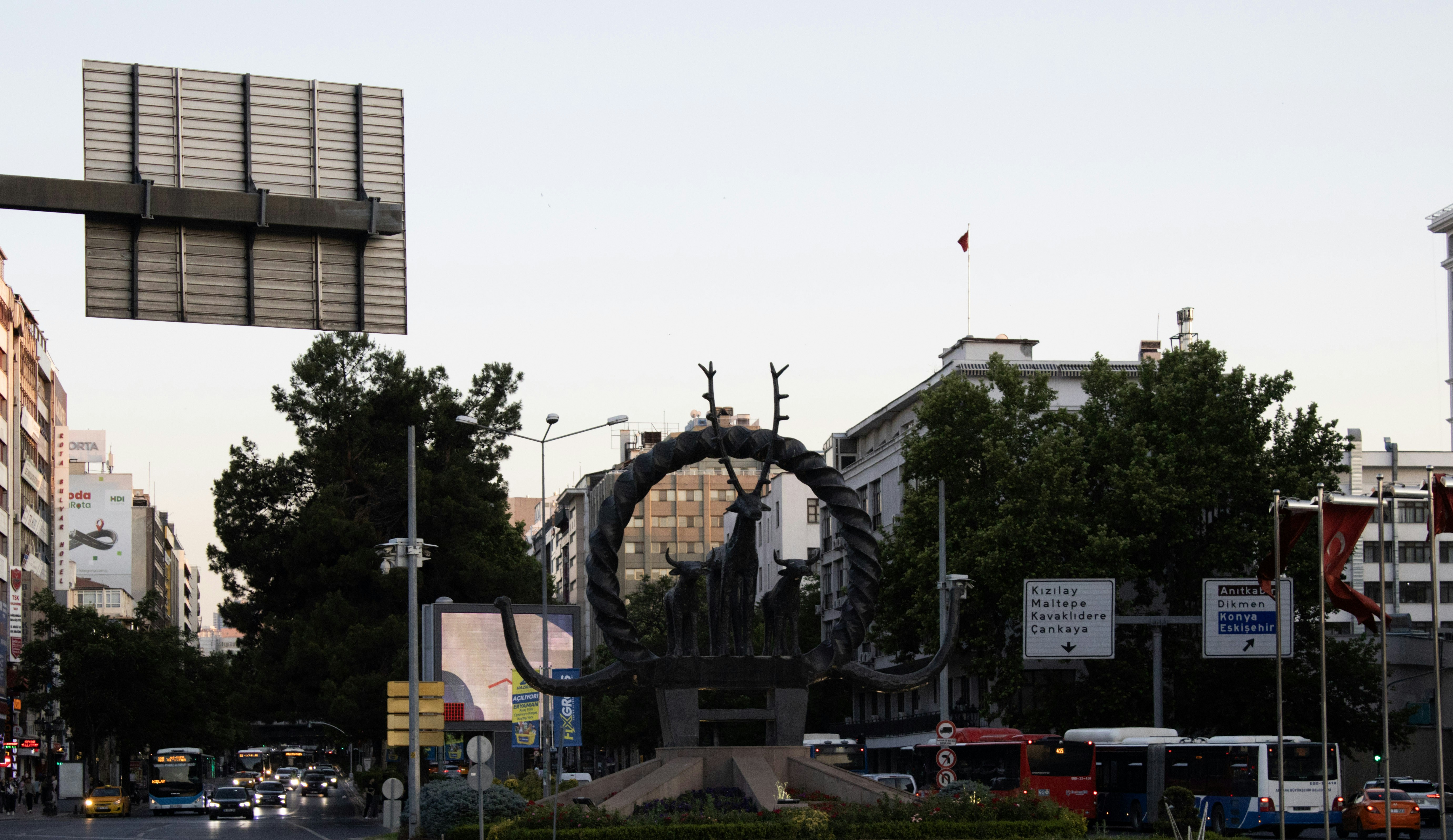 Urban Monument: Circular Sculpture Framed by City Veil