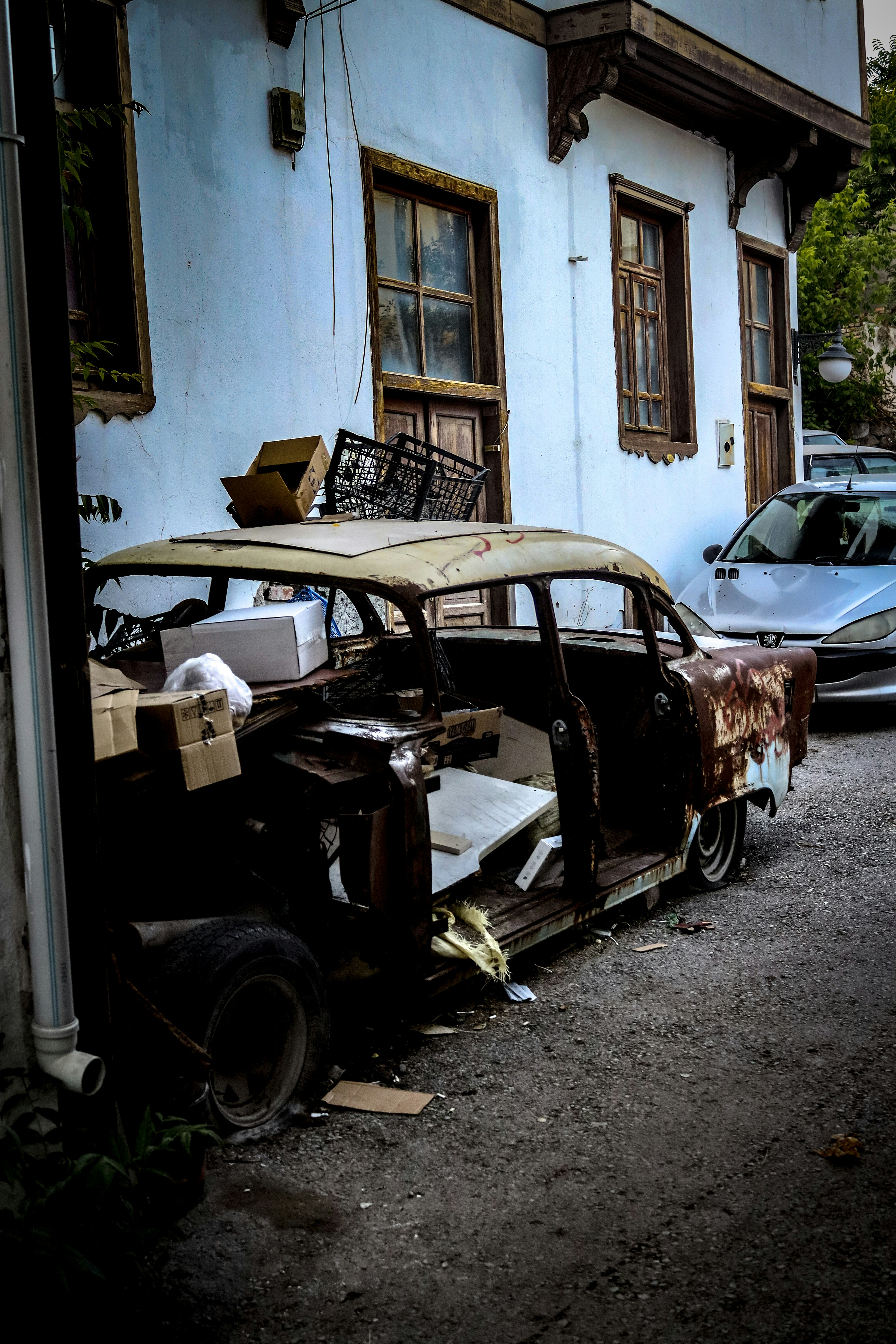 Rusting relic by the blue building