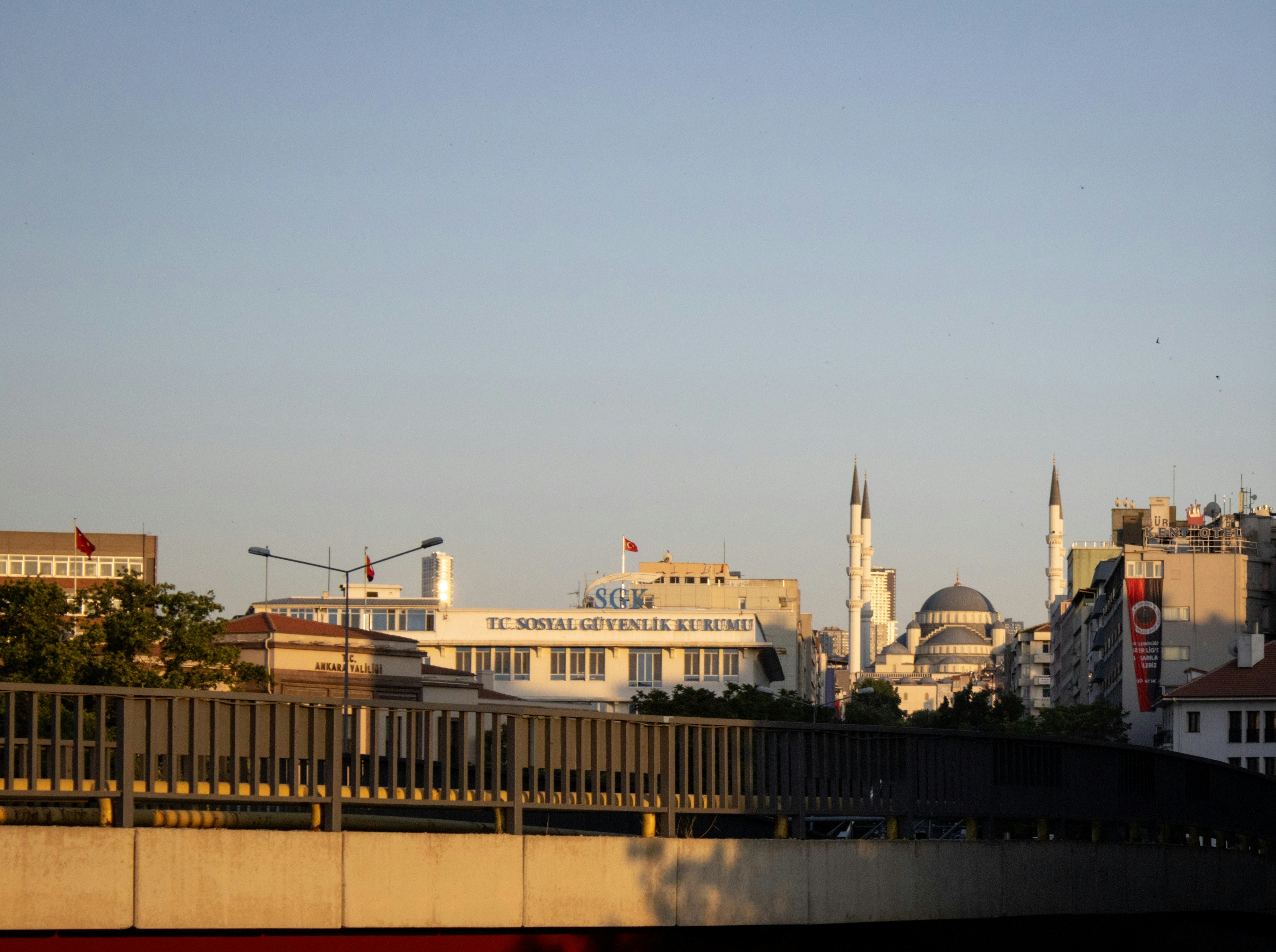 Rising Skyline Silhouettes Over a Riverside Highway