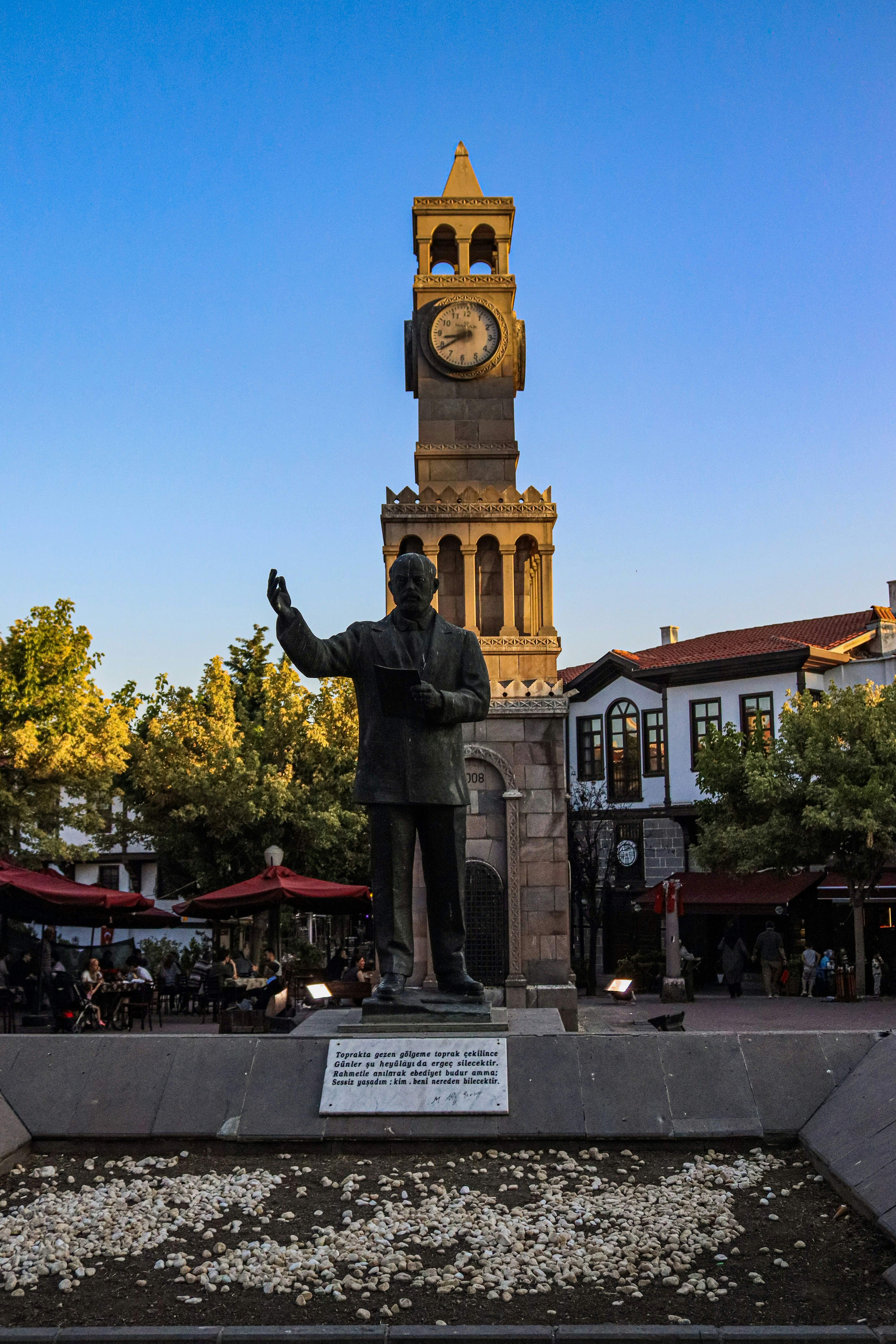 Towering Clock and Statue: A Quiet Squarescape at Dusk