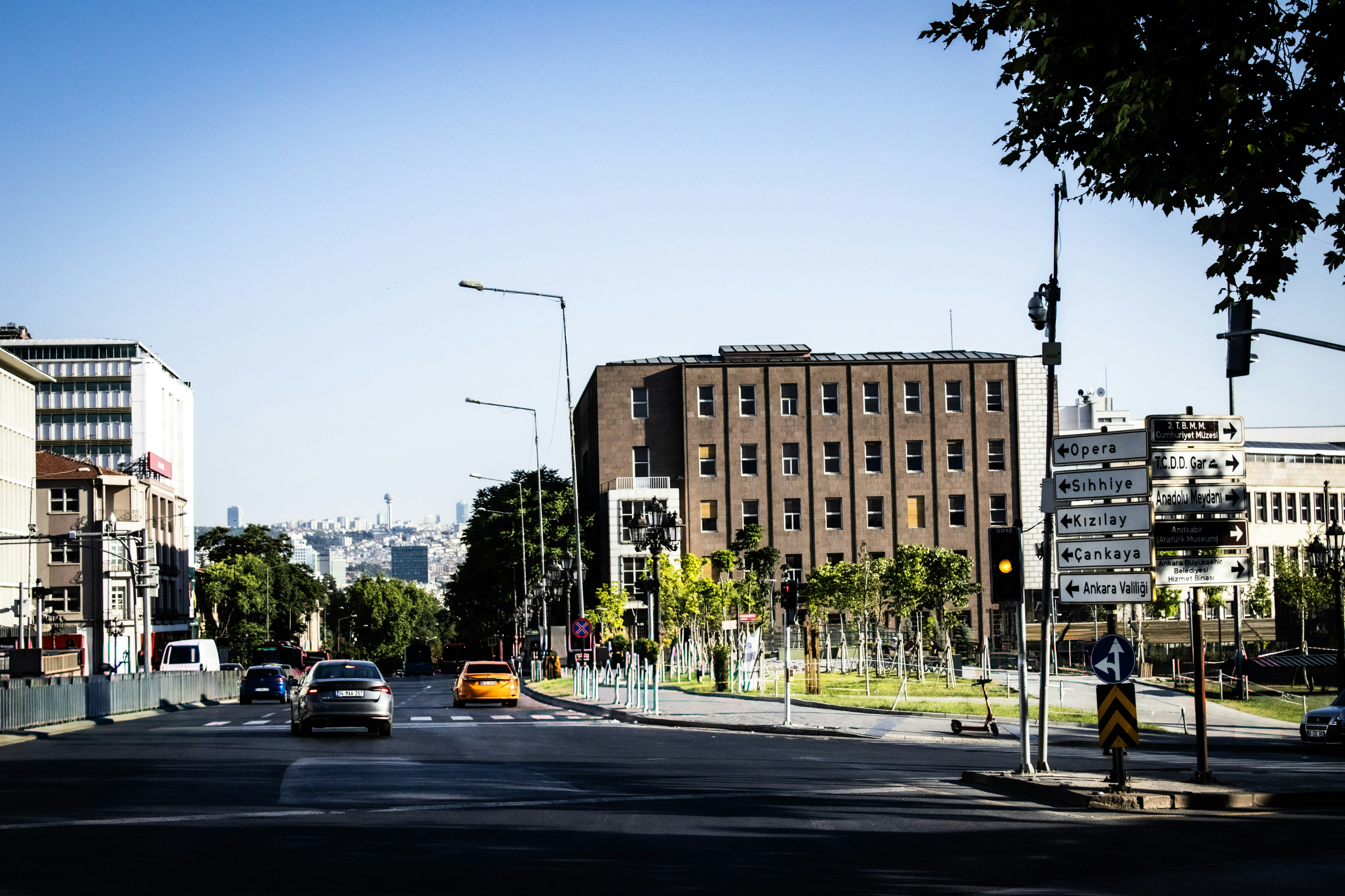 City Street Avenues: Cars Glide Past a Brick Admin Building