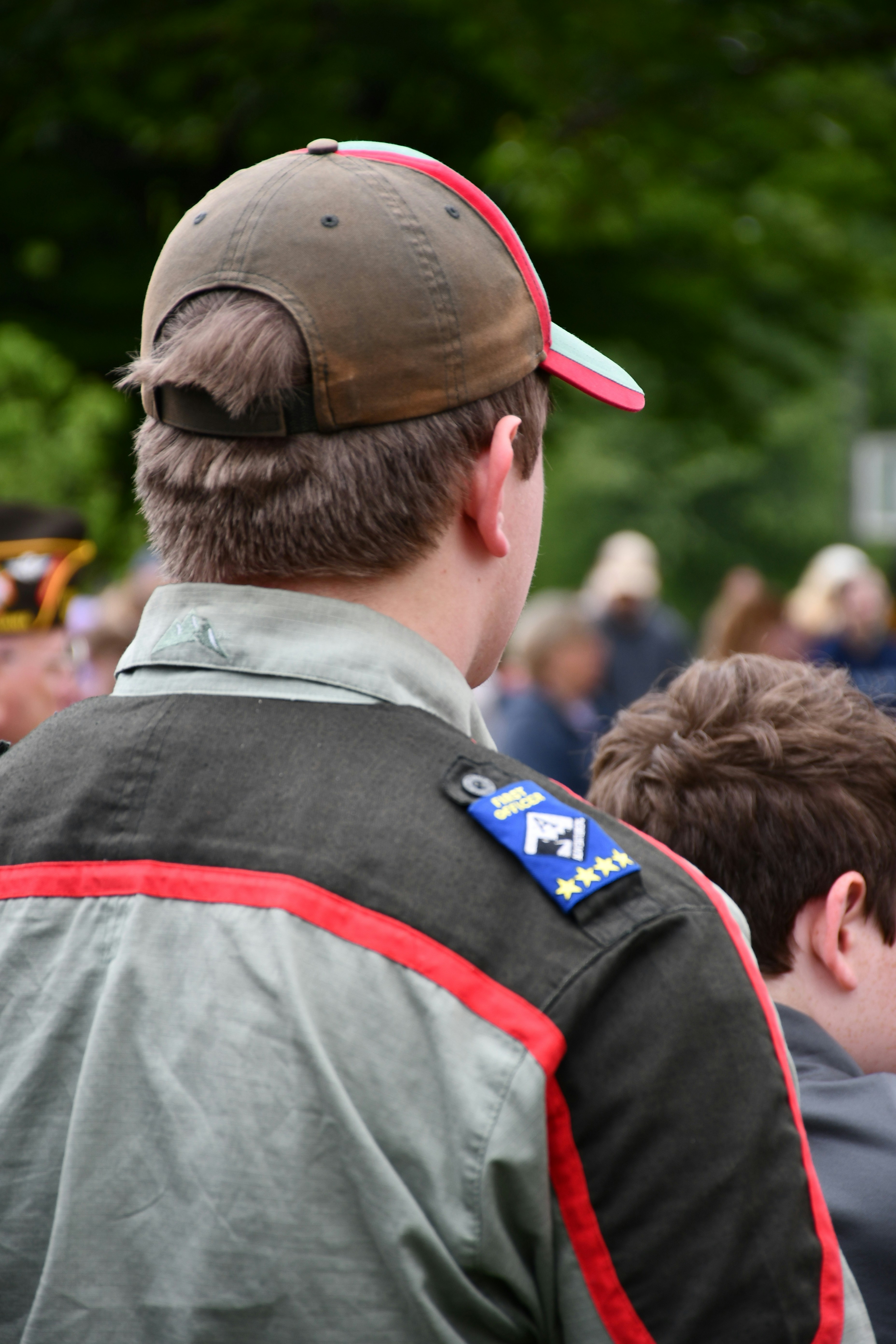 Back of a Uniformed Observer: A Crowd Behind and Beside