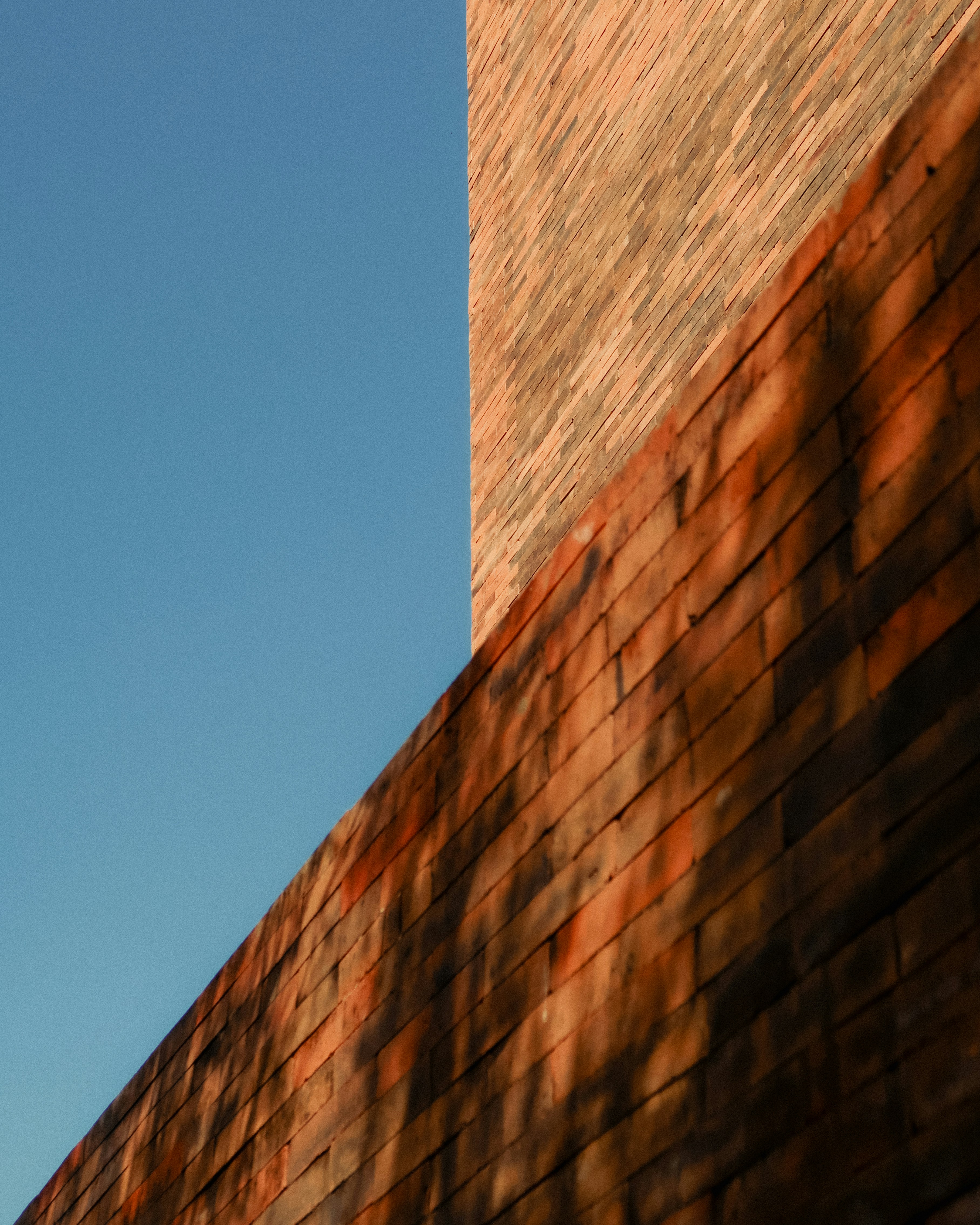 Brick Angle: A Diagonal Terrace Against a Clear Sky