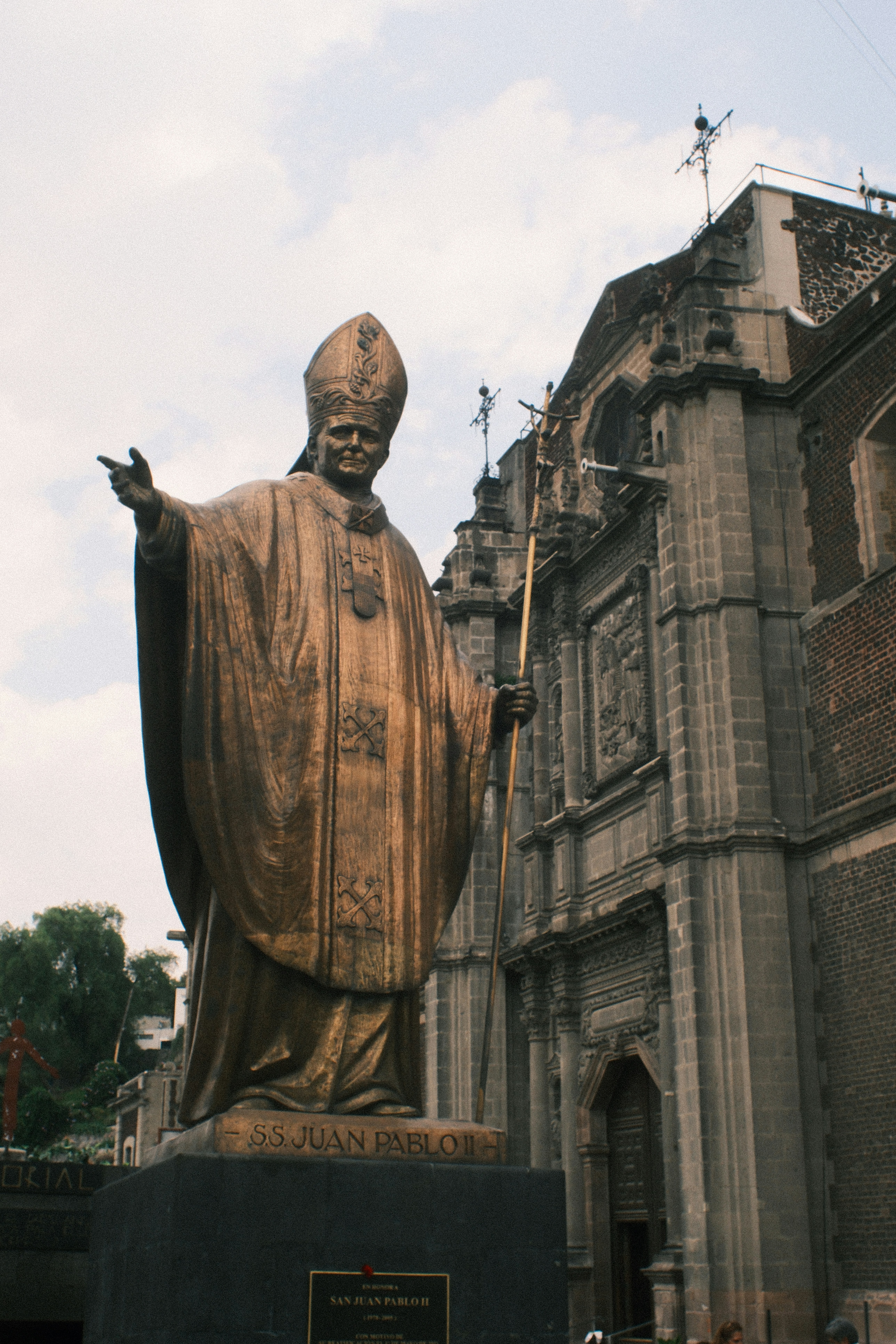 Saintly Stance: A Bronze Bishop Overlooking the Plaza