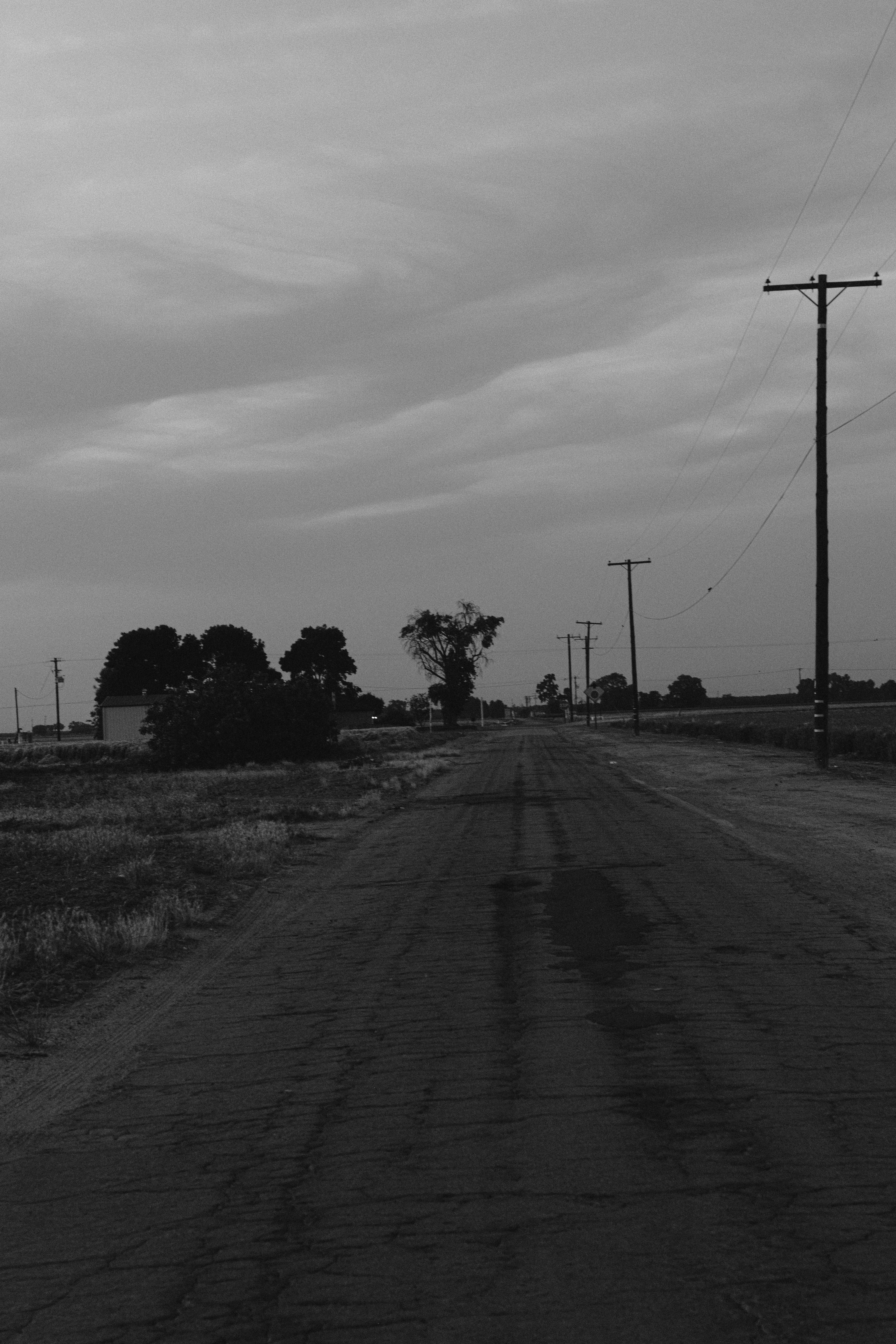 Desolate Rural Road Beneath Wide Prairie Skies