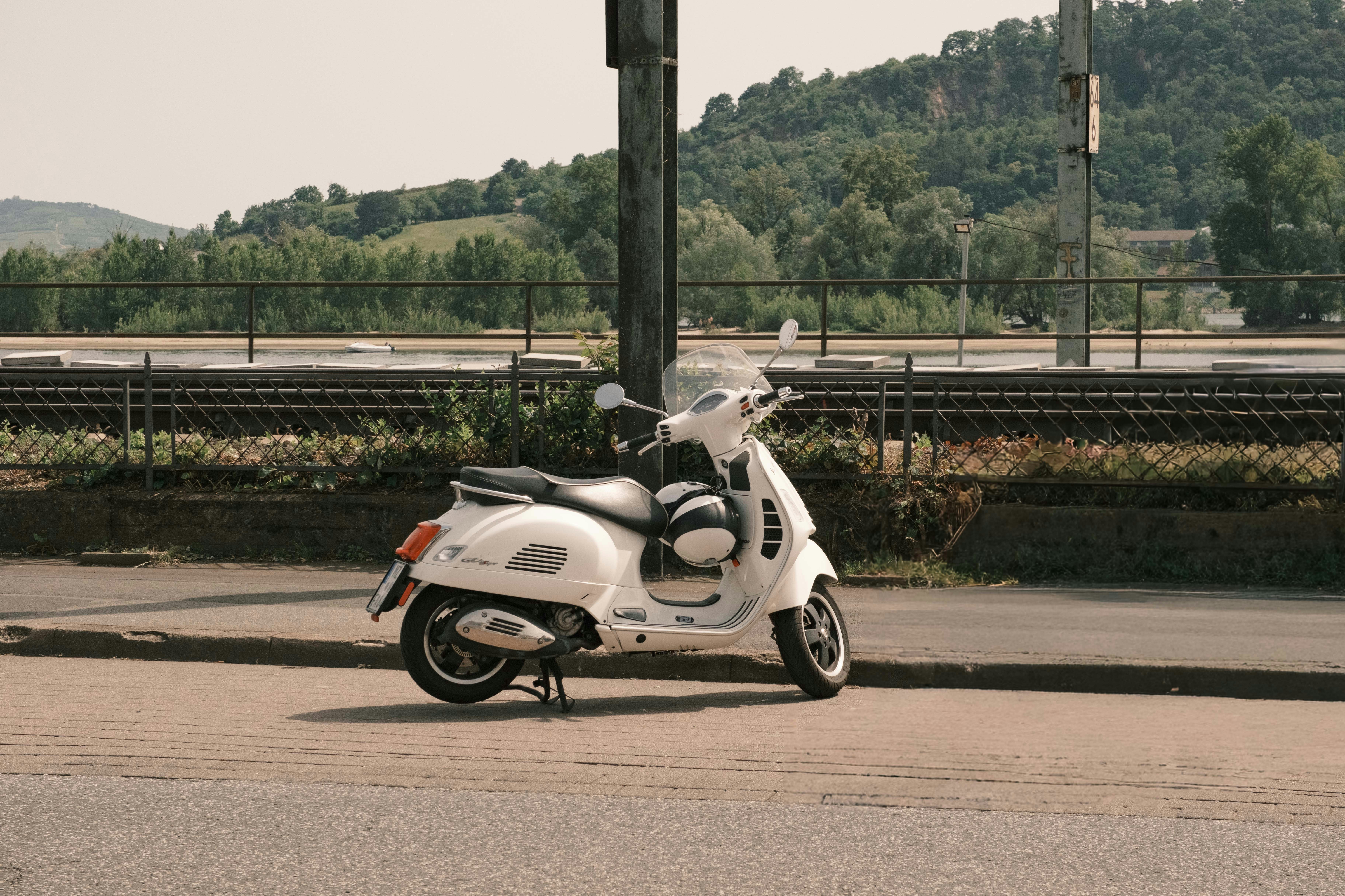 White Vespa by the Riverside Rail