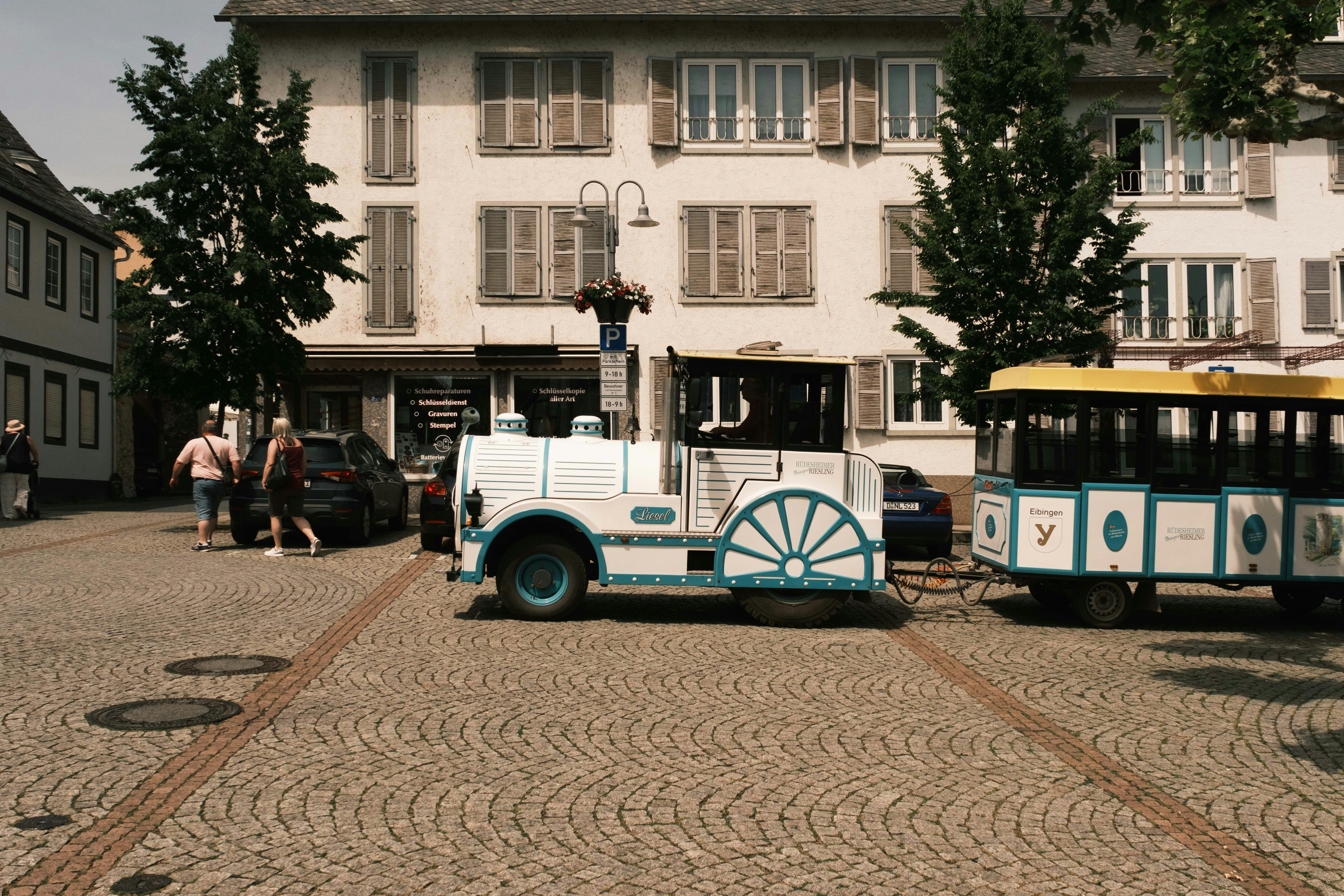 Pastel Parade: A Town Square Train Resting by Historic Facades