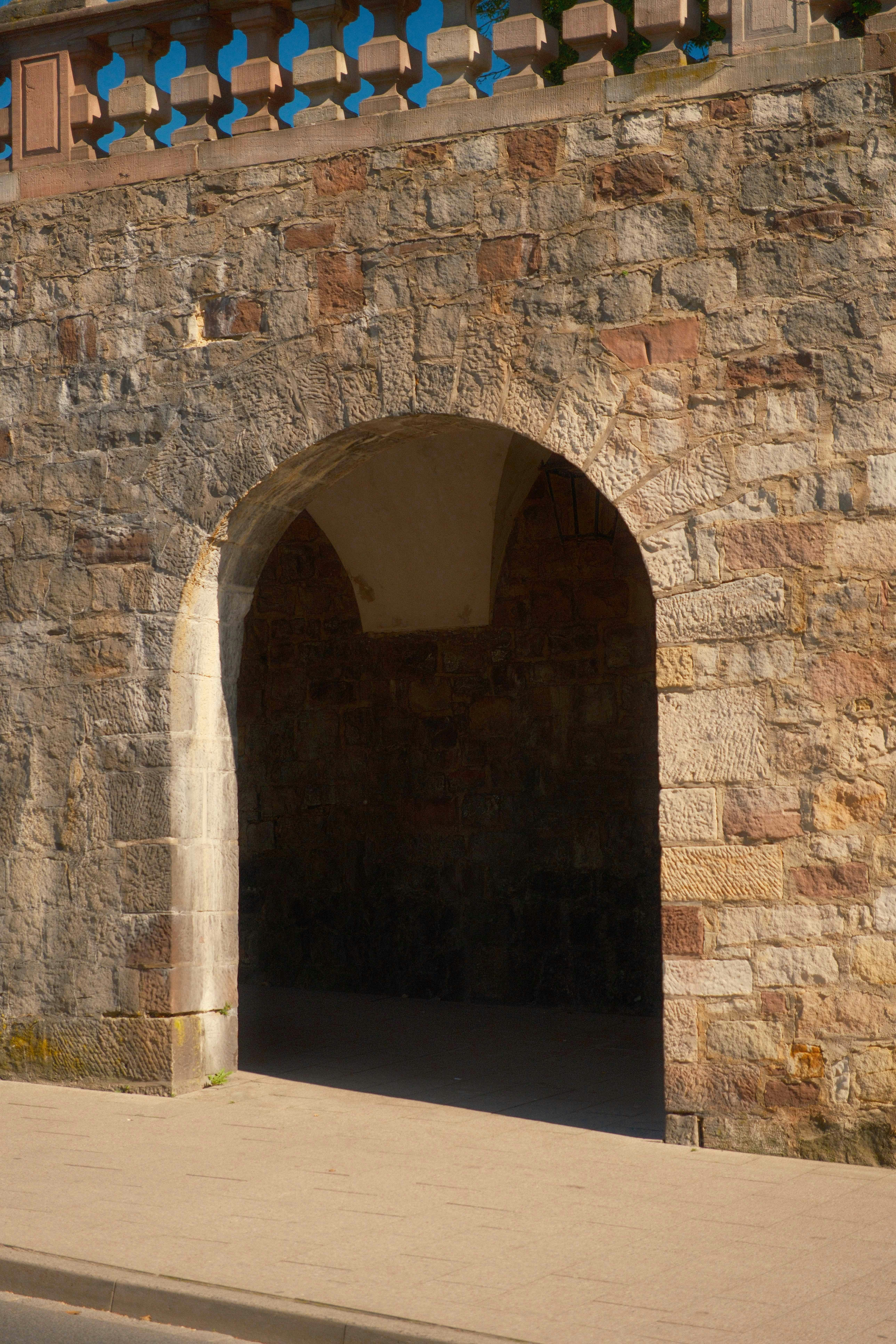 Stone Archway into Shadowed Passage