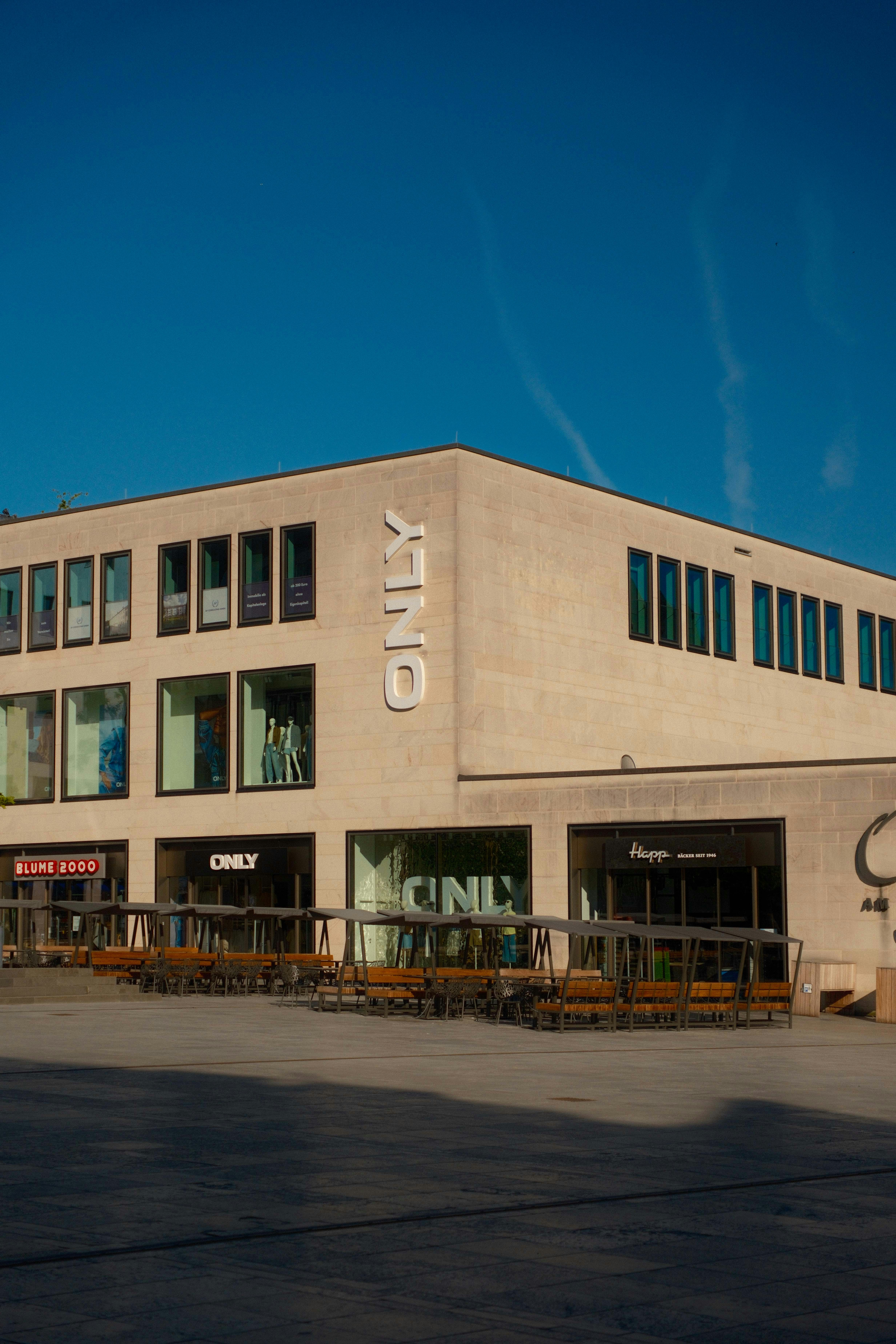 Urban Gallery: The Sunlit Neutral façade of a Modern Shopping Block