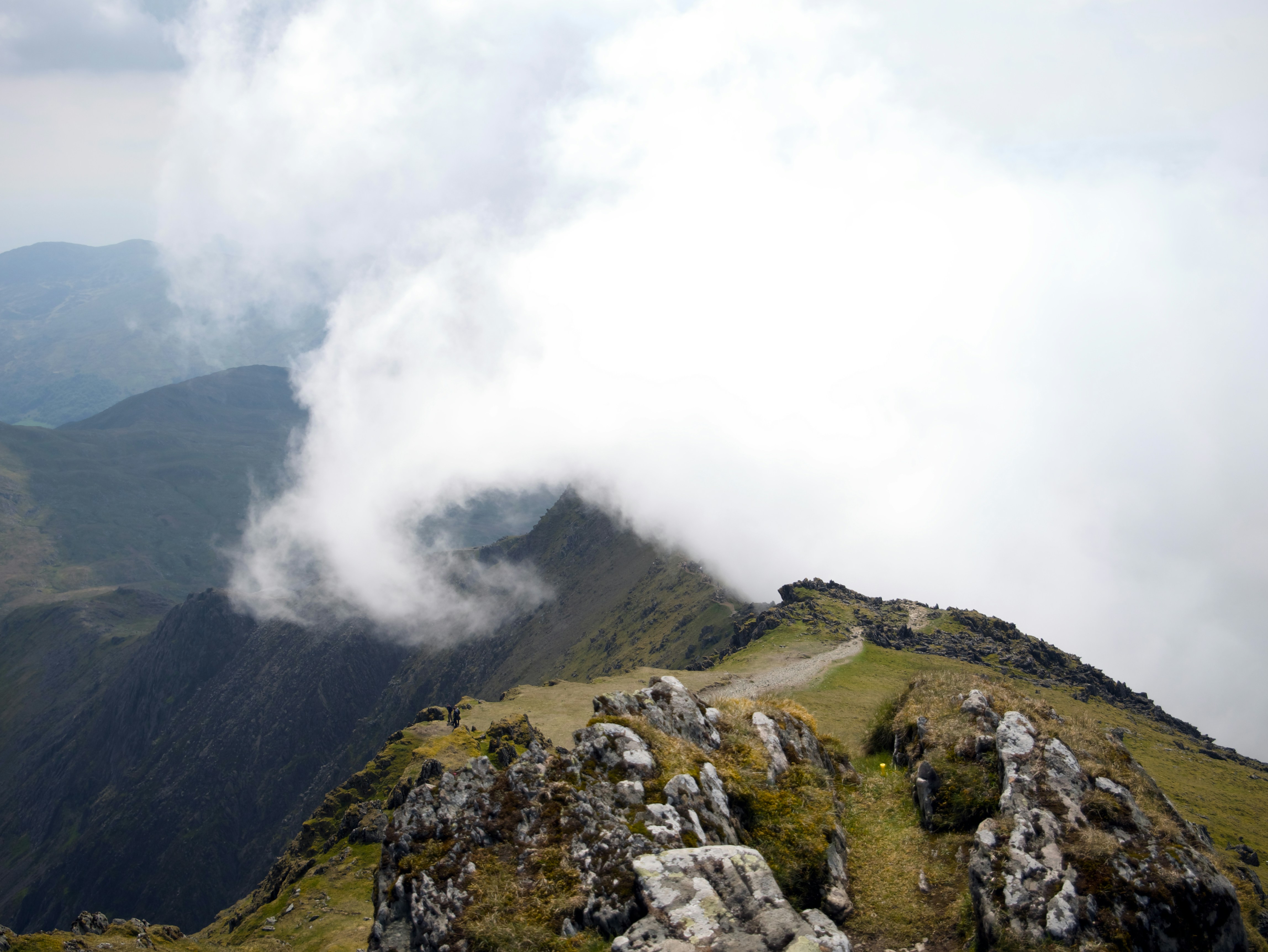 Ridge Crest Under a Veil: A Moment on the Mountain Peak