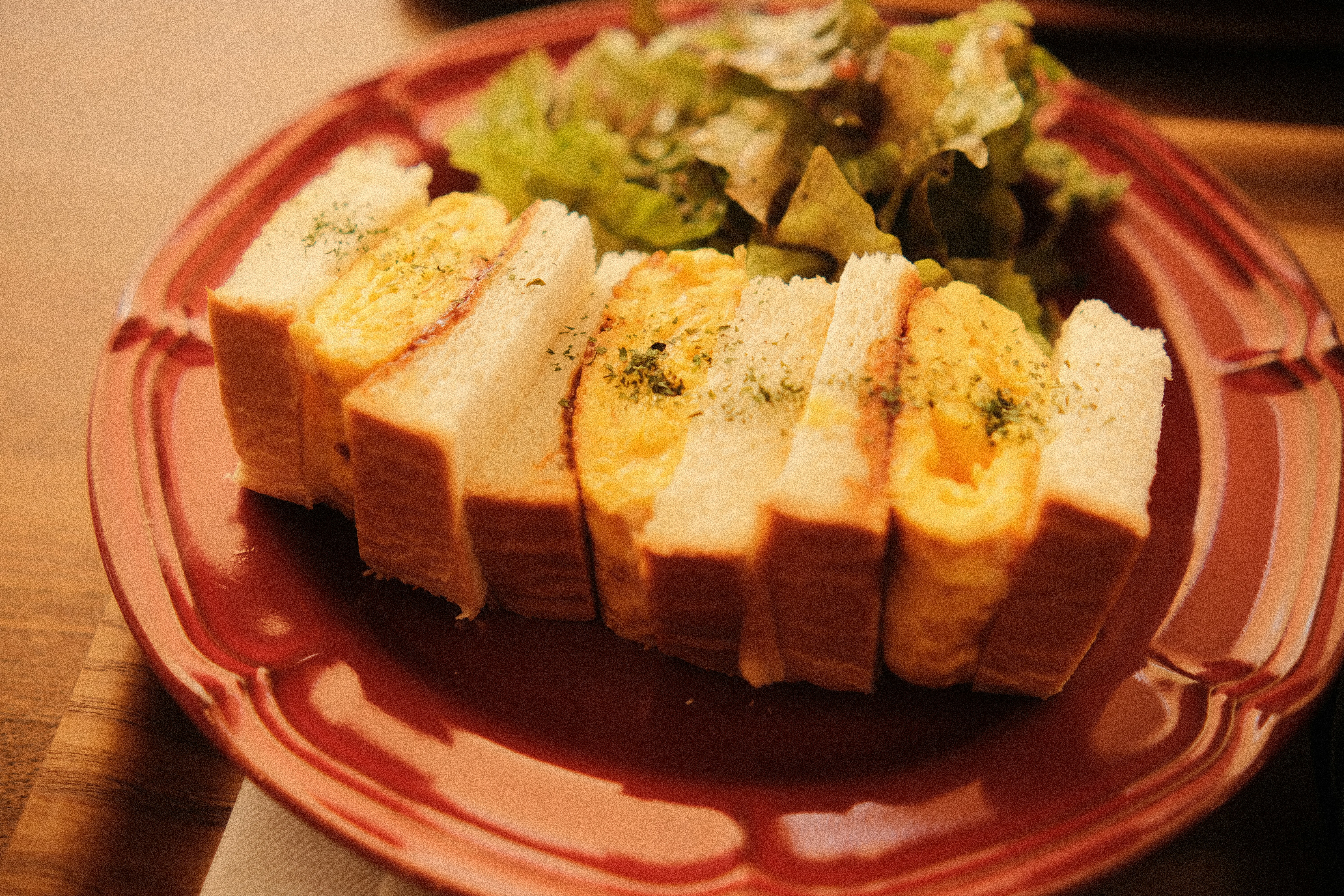 Golden Egg Salad Slices on a Crimson Plate