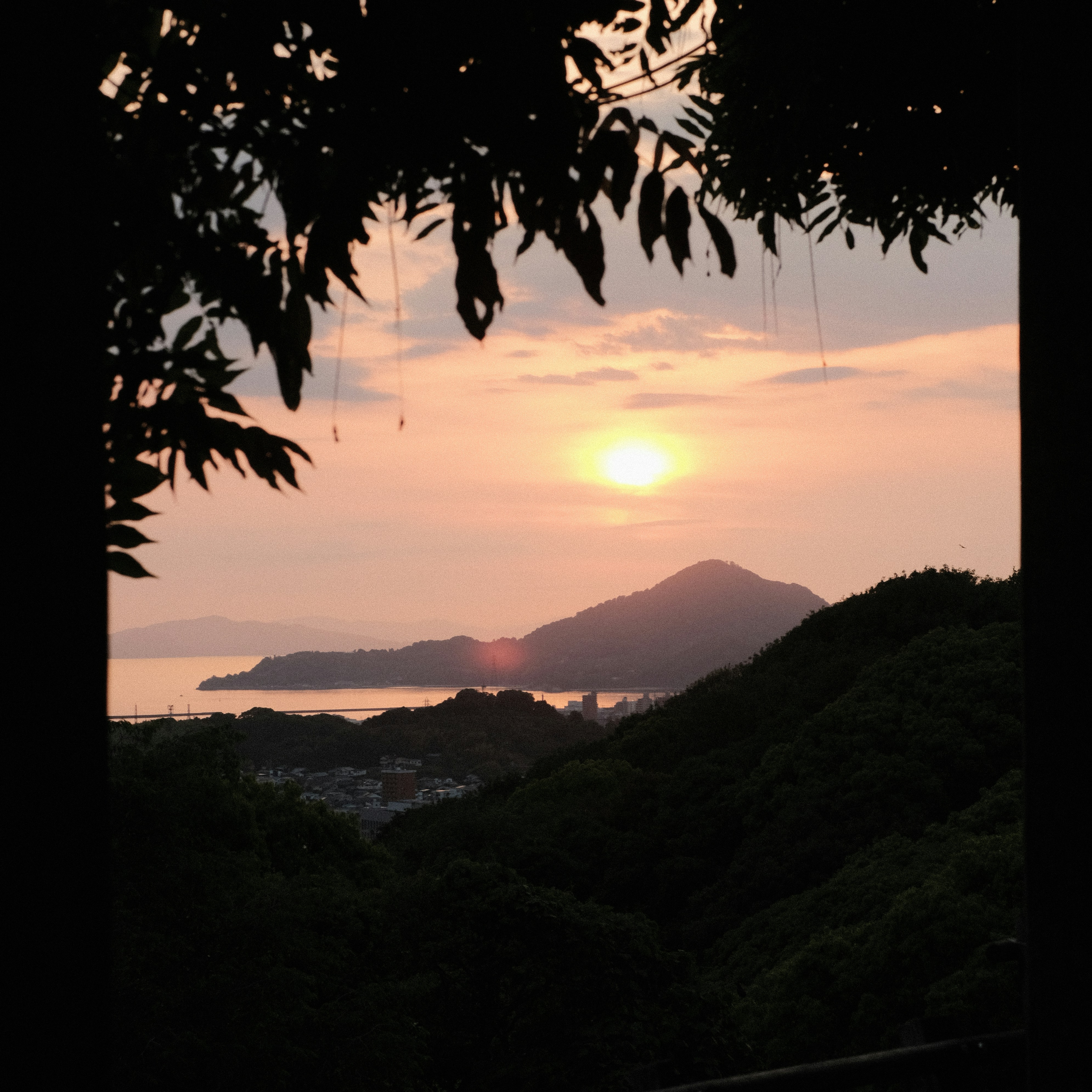 Sunset Over Coastal Hills: A Framed Dusk