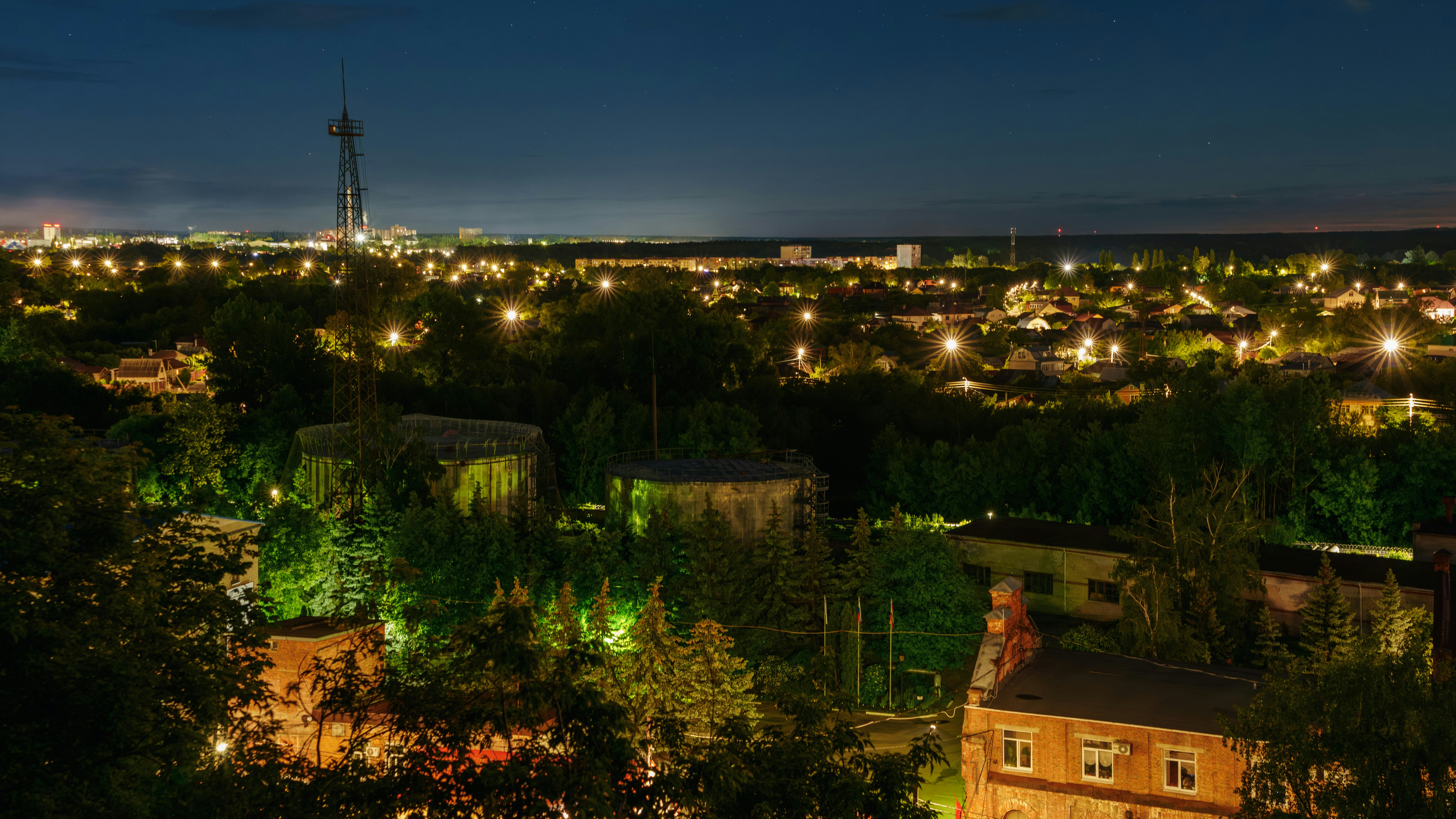 Nightfall Over a Quiet Cityscape with a Distant Tower