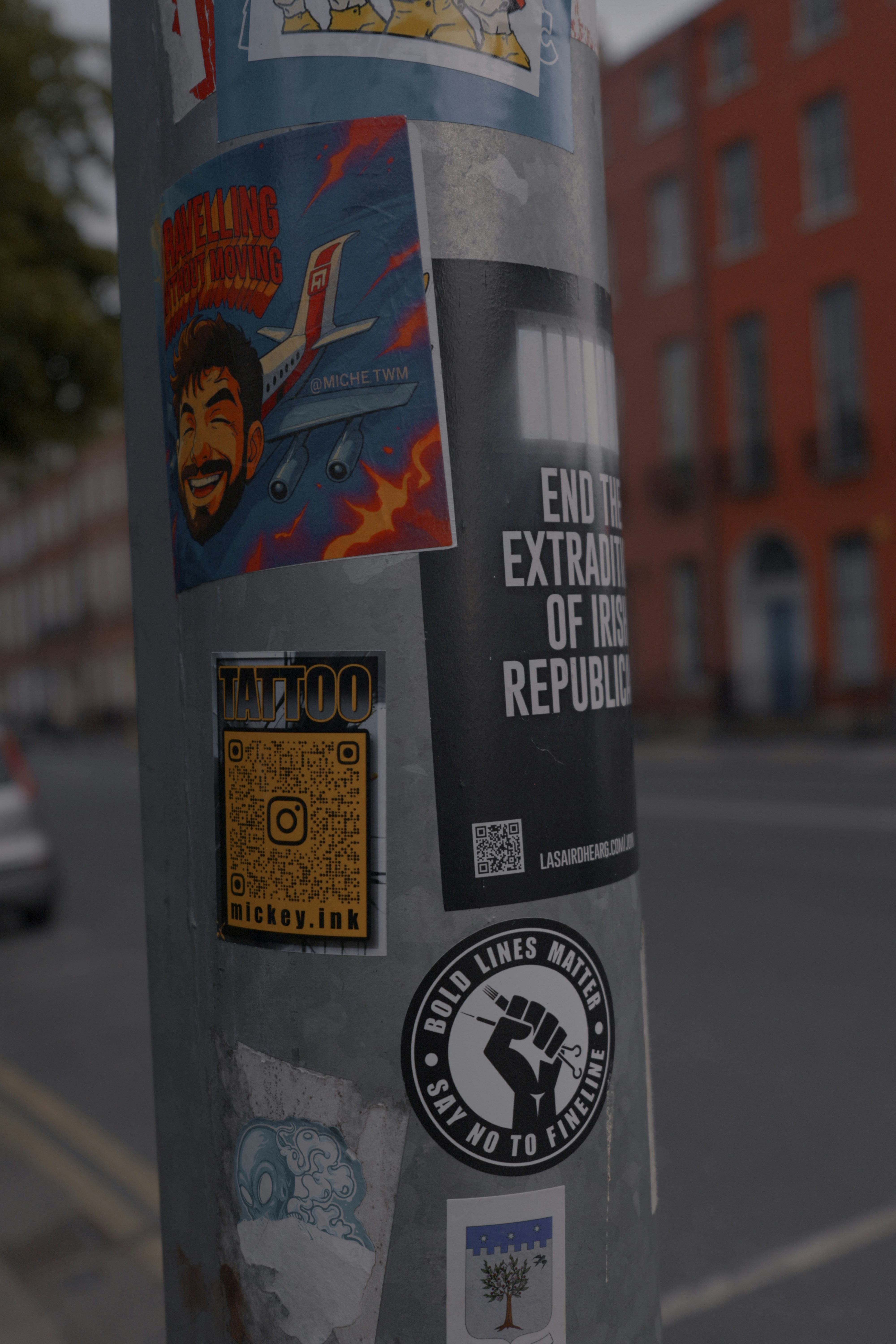 Stickered Urban Post: A Clutch of Quiet Messages on a City Pole