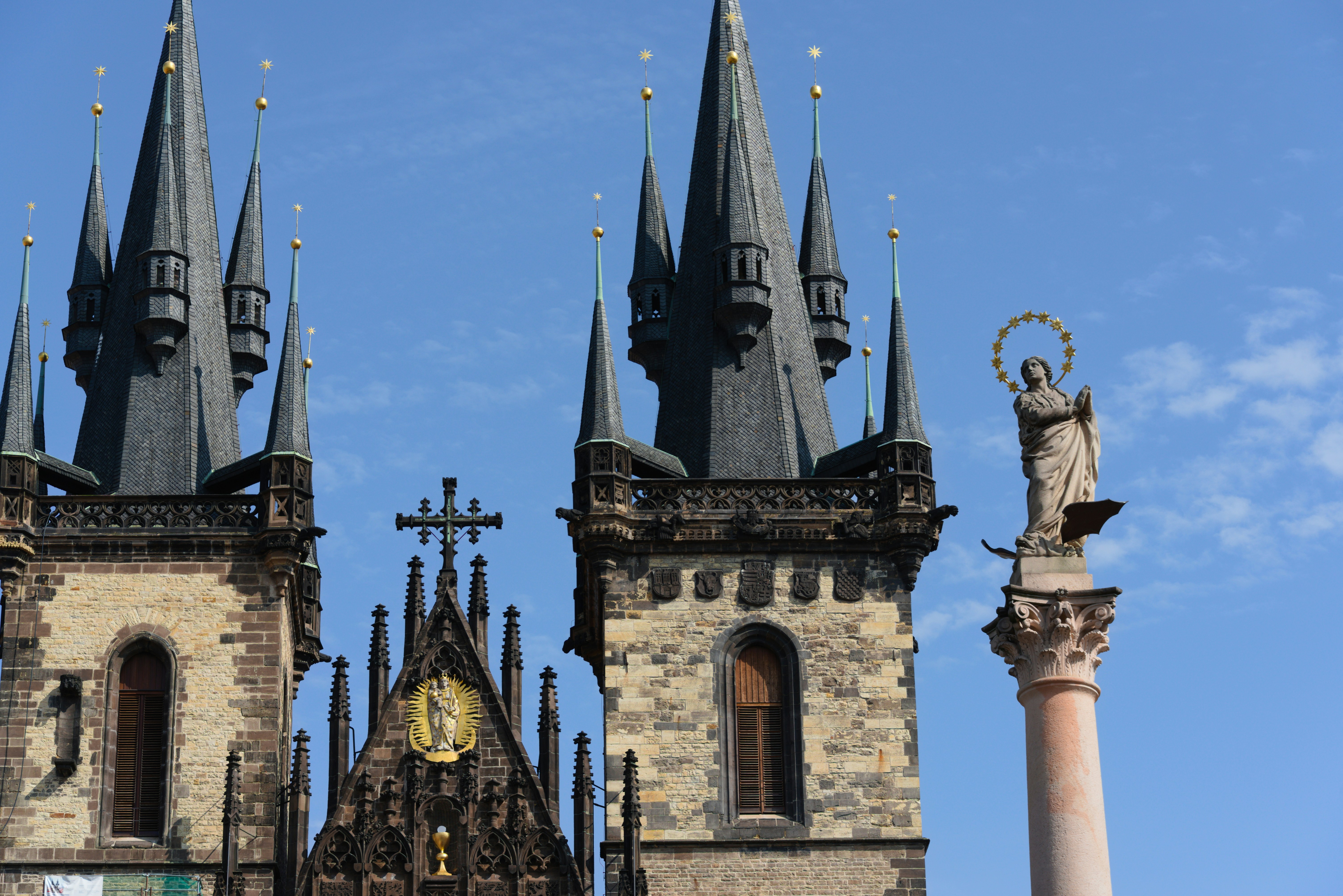 Spirefront at Dawn: Gothic Towers and a Haloed Statue