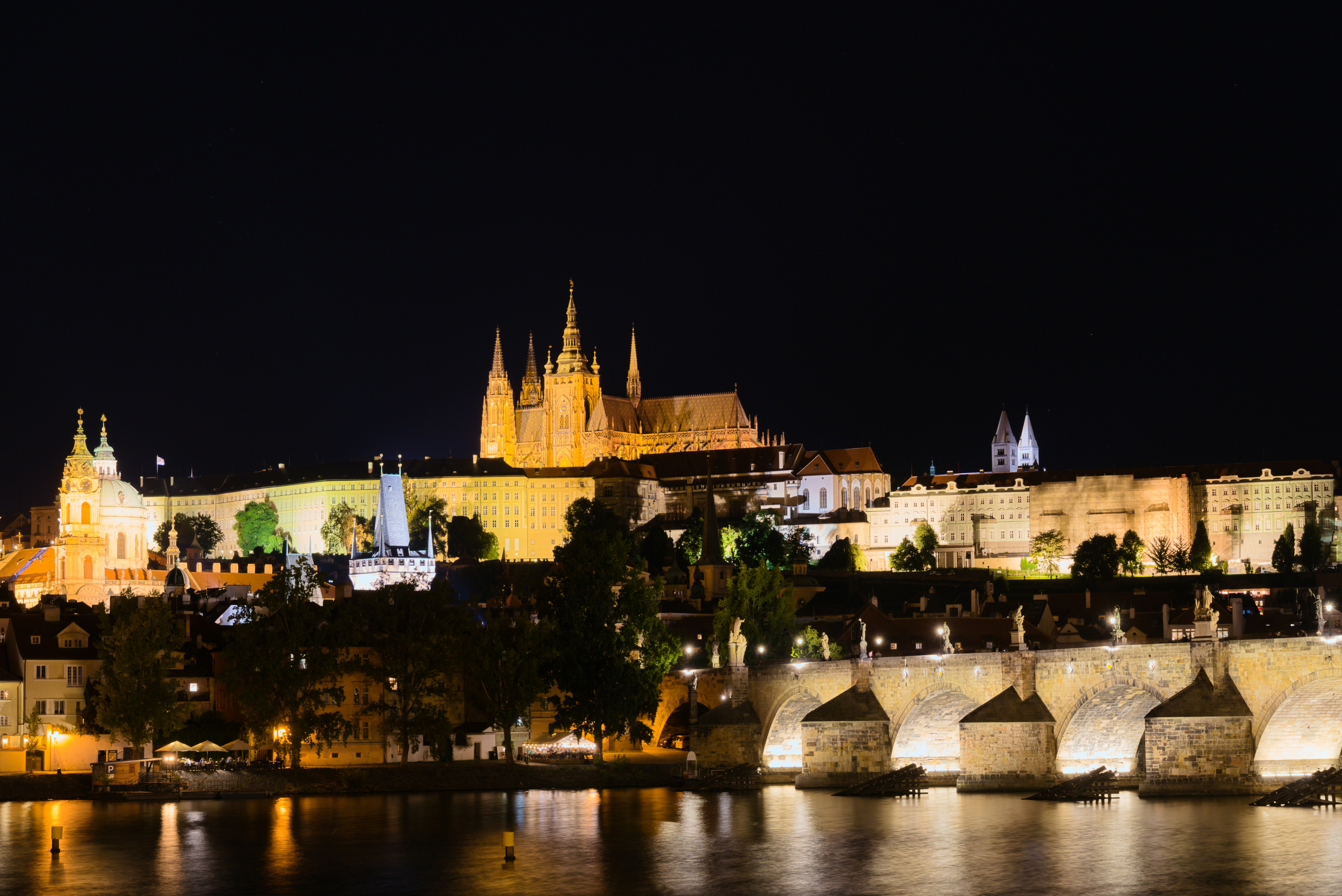 Moonlit Prague: Riverside Fortress and Old Bridge in Warm Glow