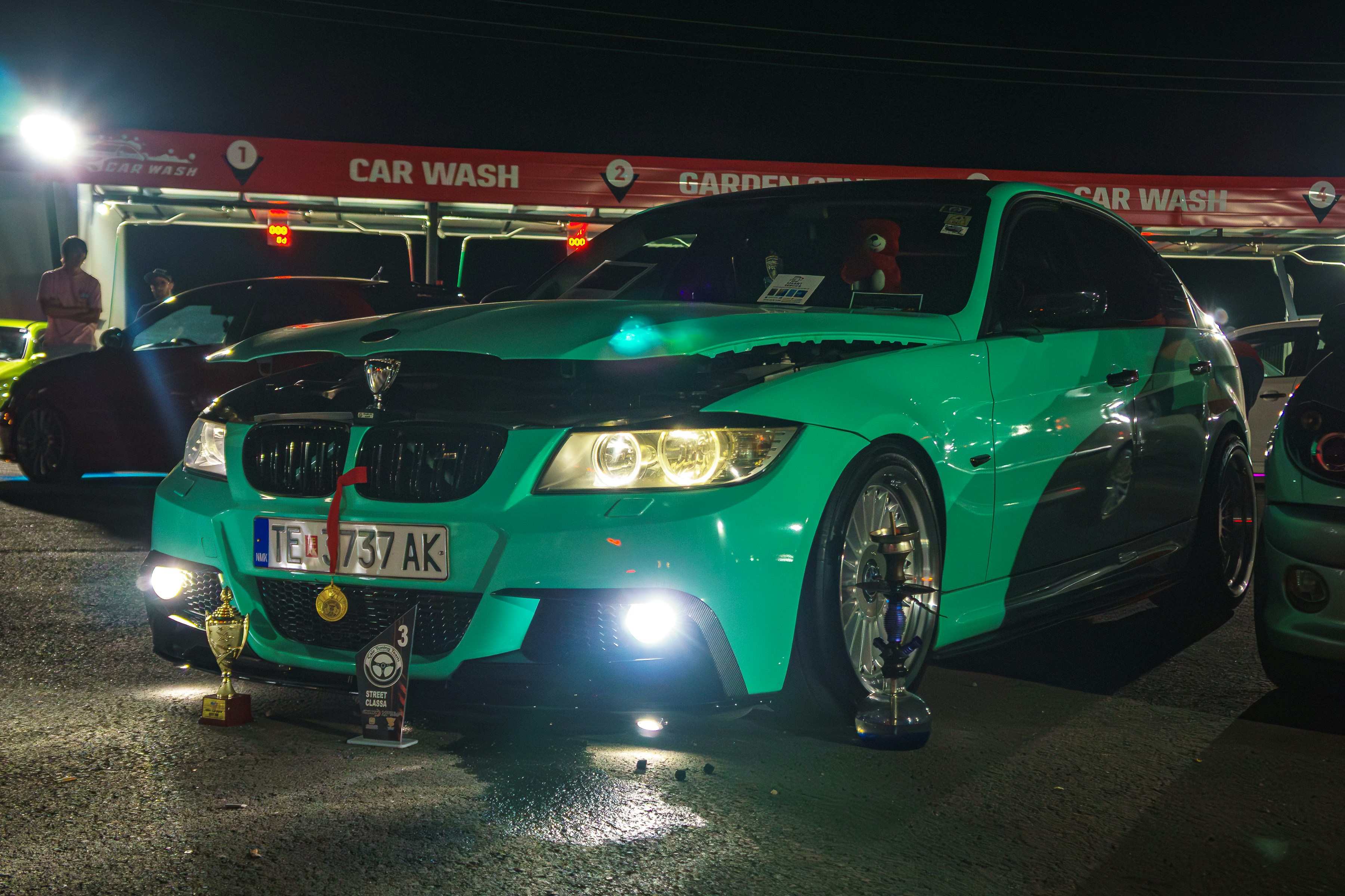 Teal Muscle in Neon Night: A Car Show Stunner