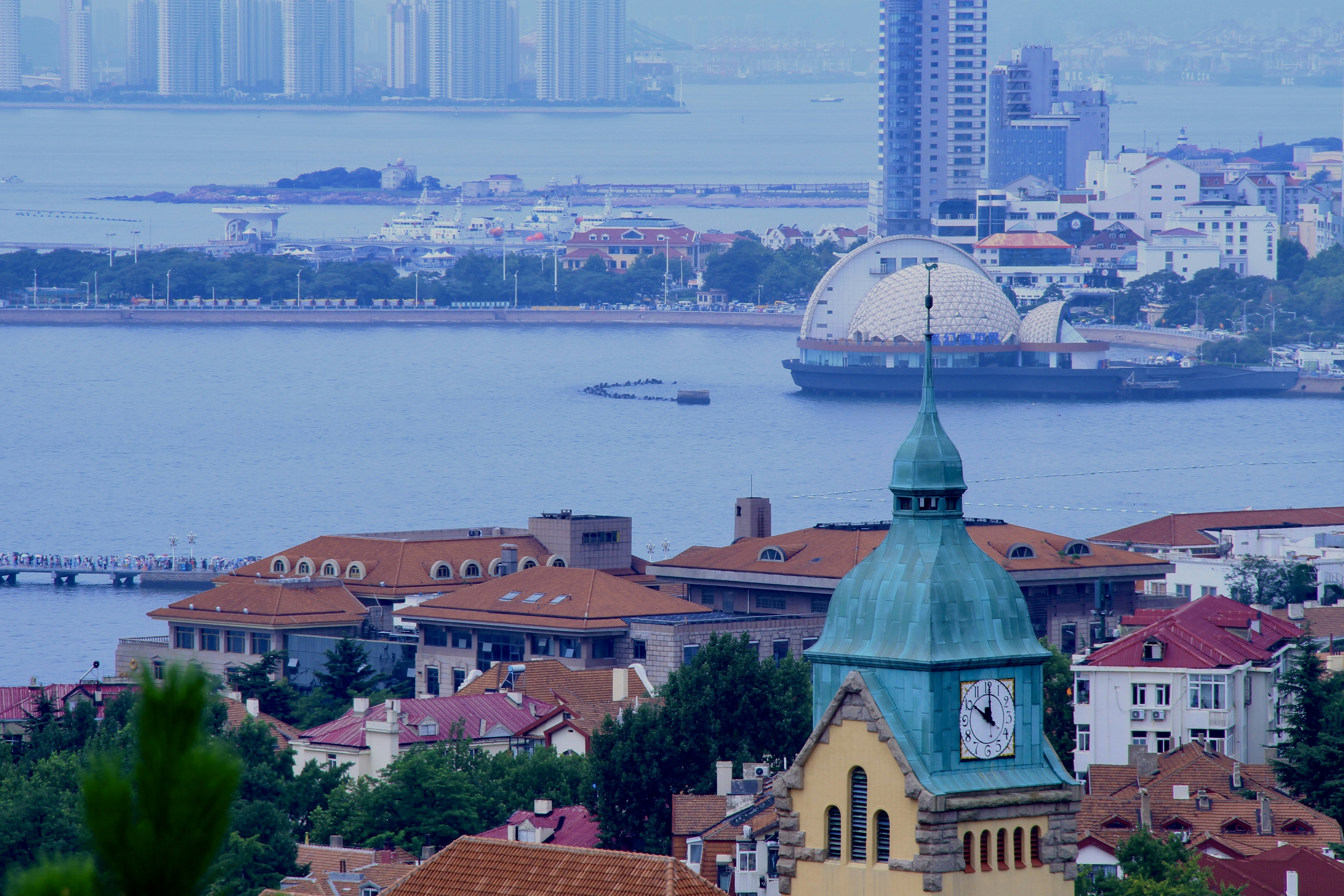 Coastal Town Silhouette: Dome and Sea Between Rooftops