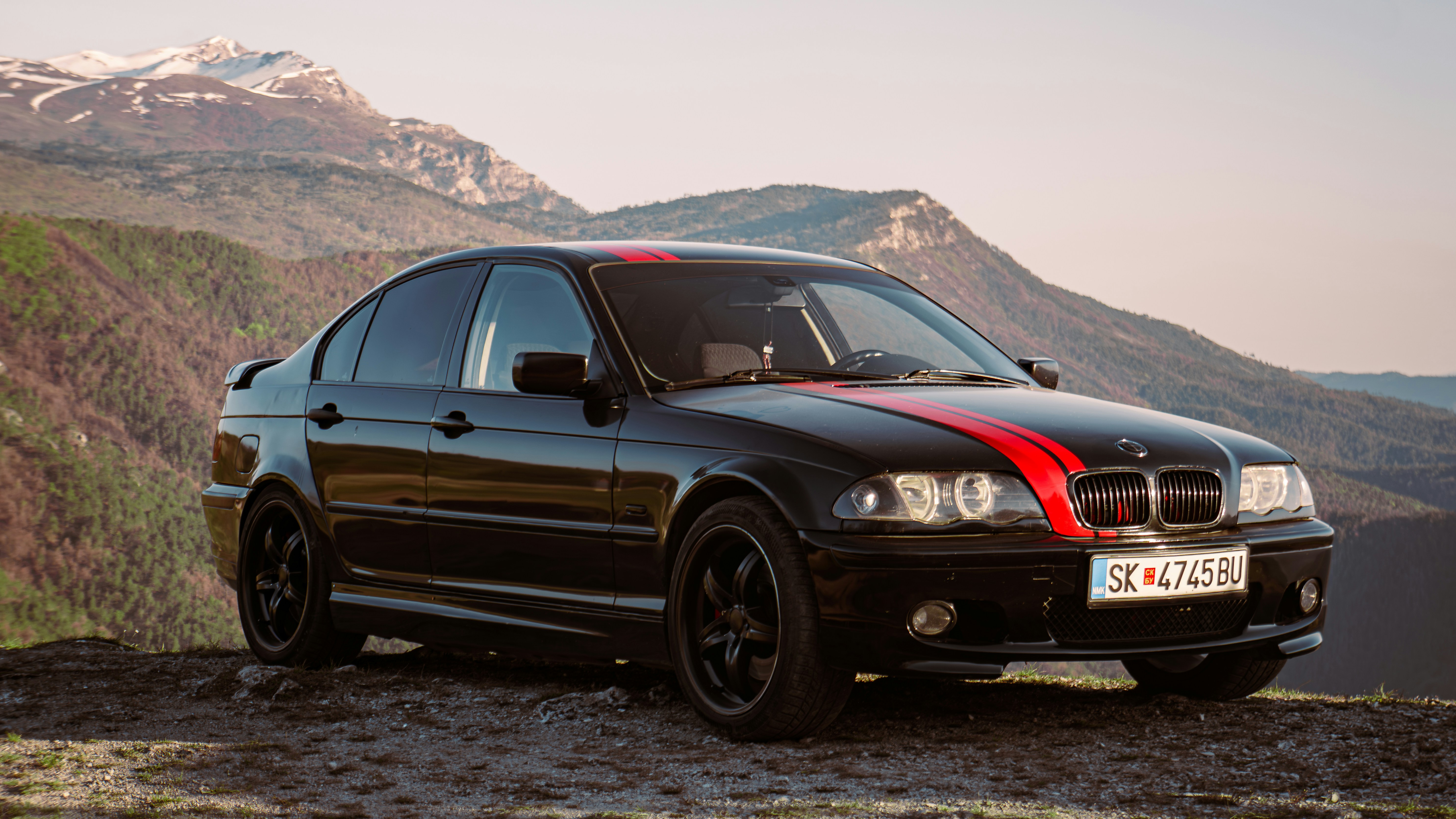 Black BMW with Racing Stripe Climbs a Mountain Overlook