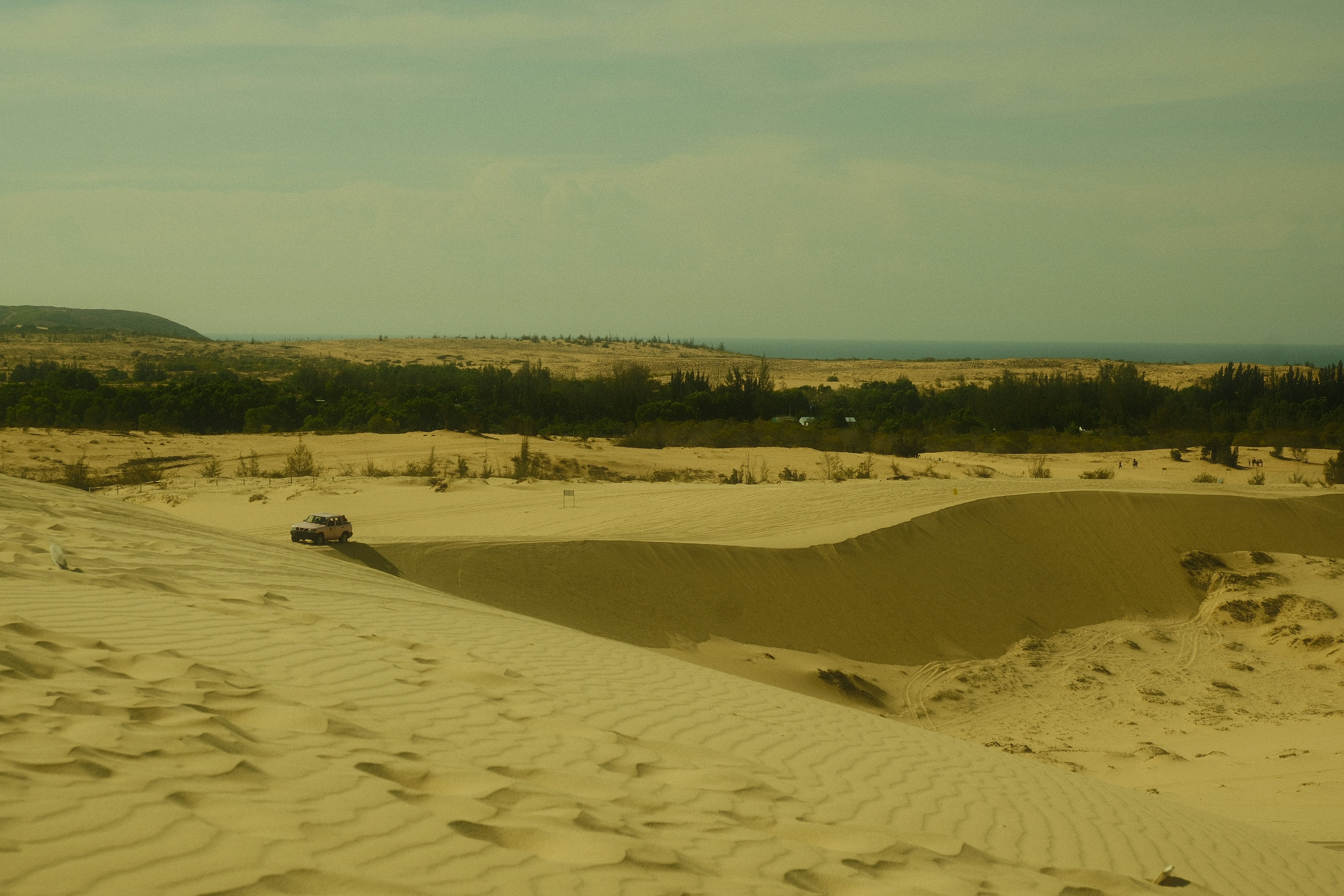 Dune Crest and Caravan Silhouette at Distant Horizon