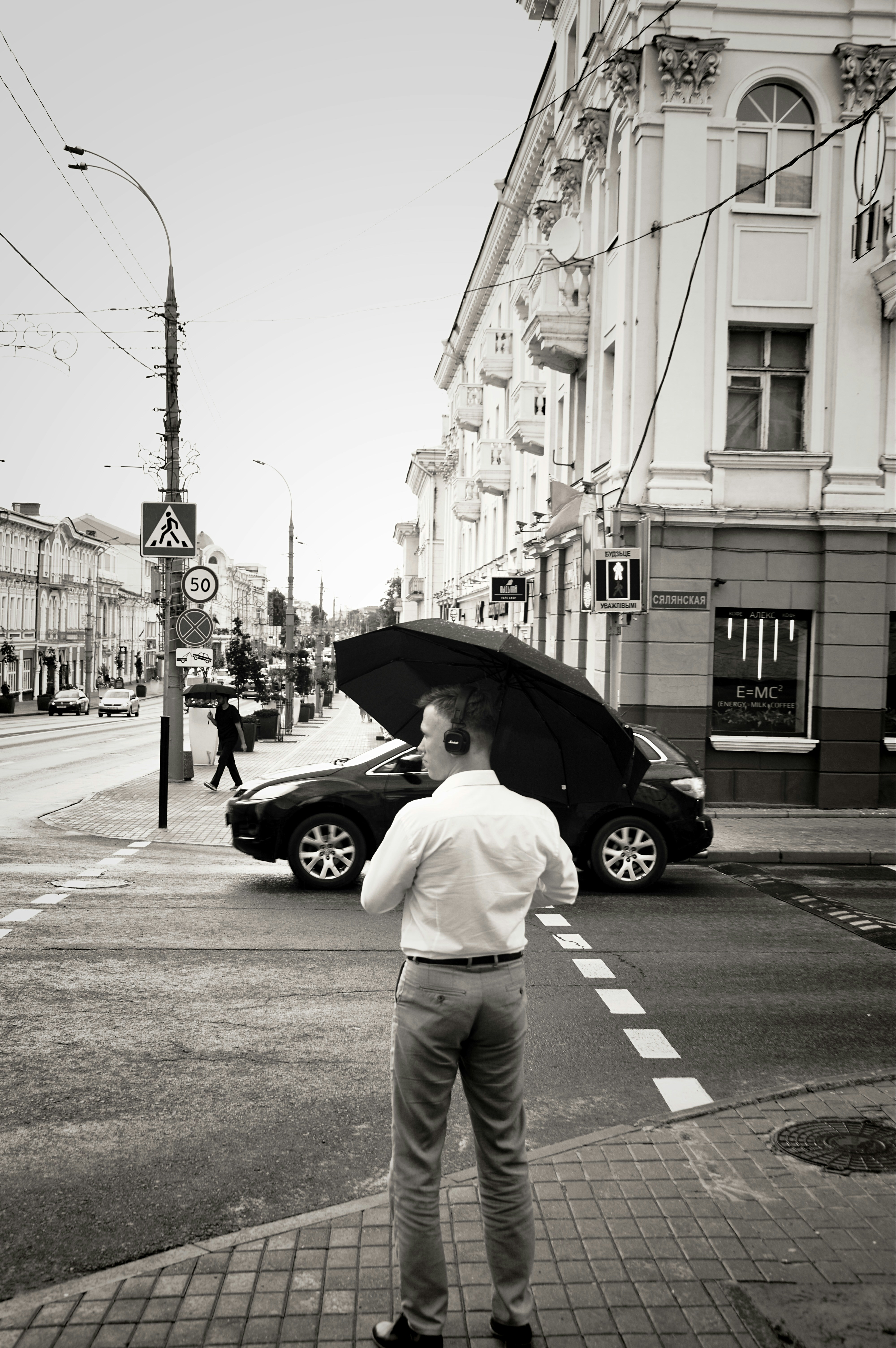 Across the Crosswalk: A Street Portrait Under Rainy City Light
