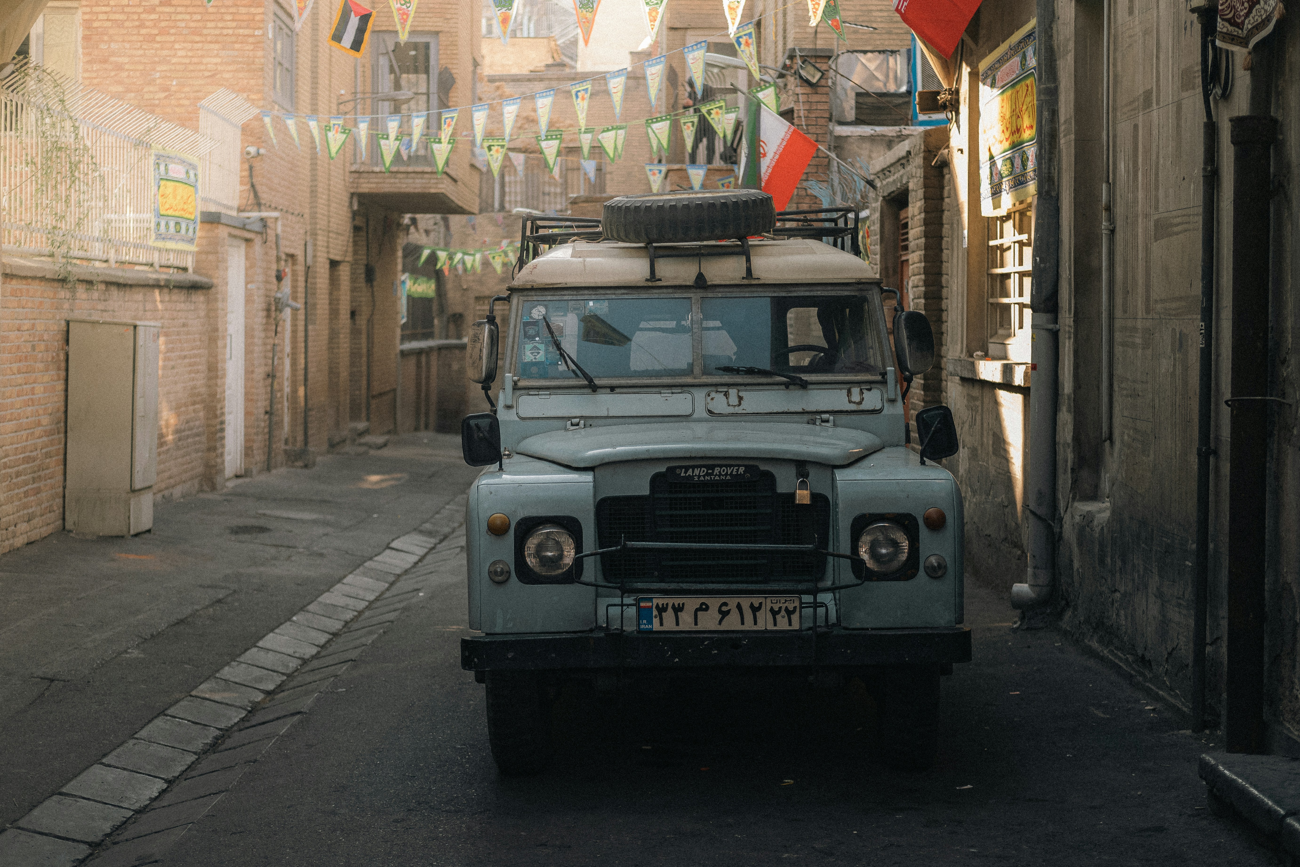 A Weathered Utility Vehicle Anchors a Narrow Alley