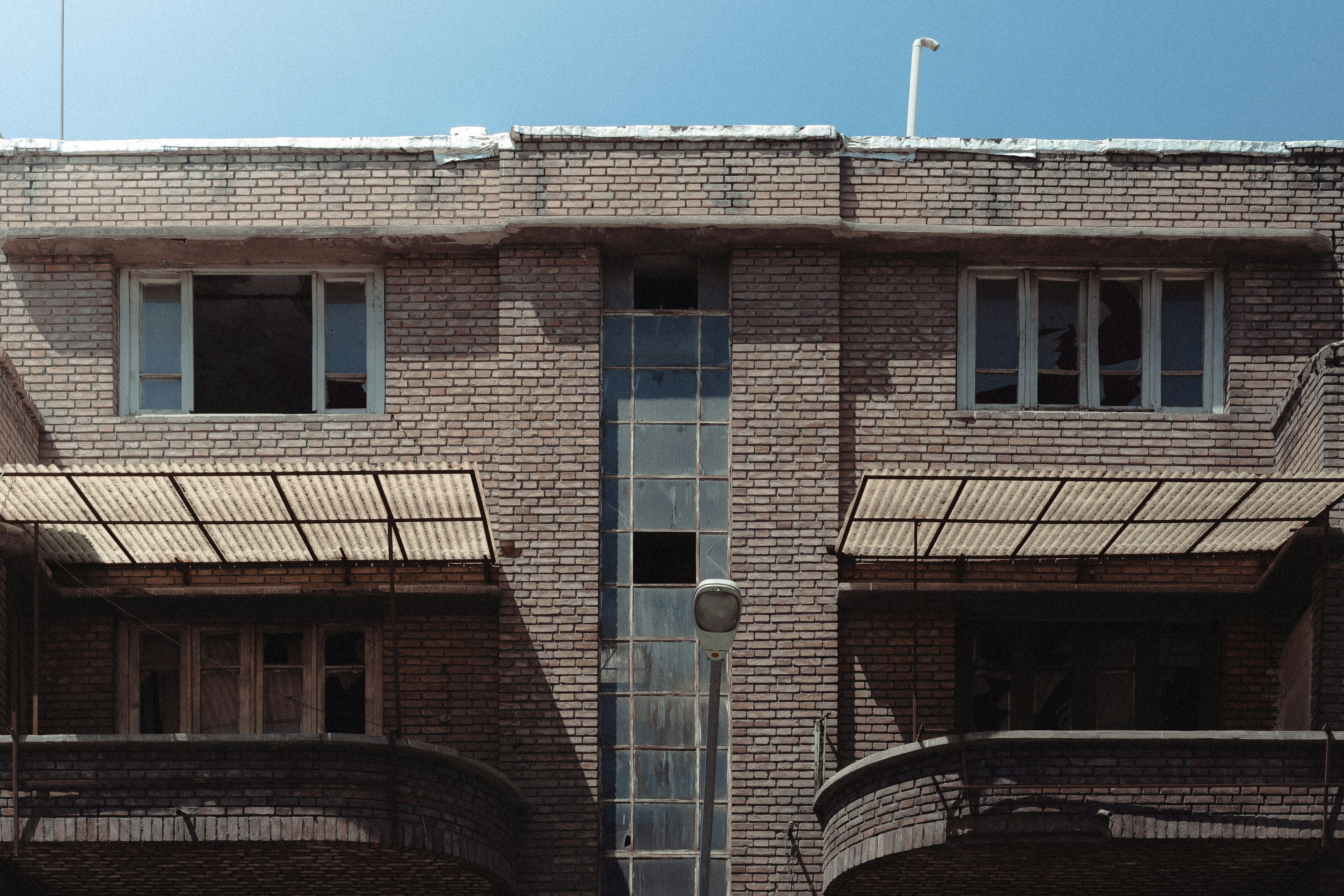 Central Glass Atrium Framed by Brick Facade
