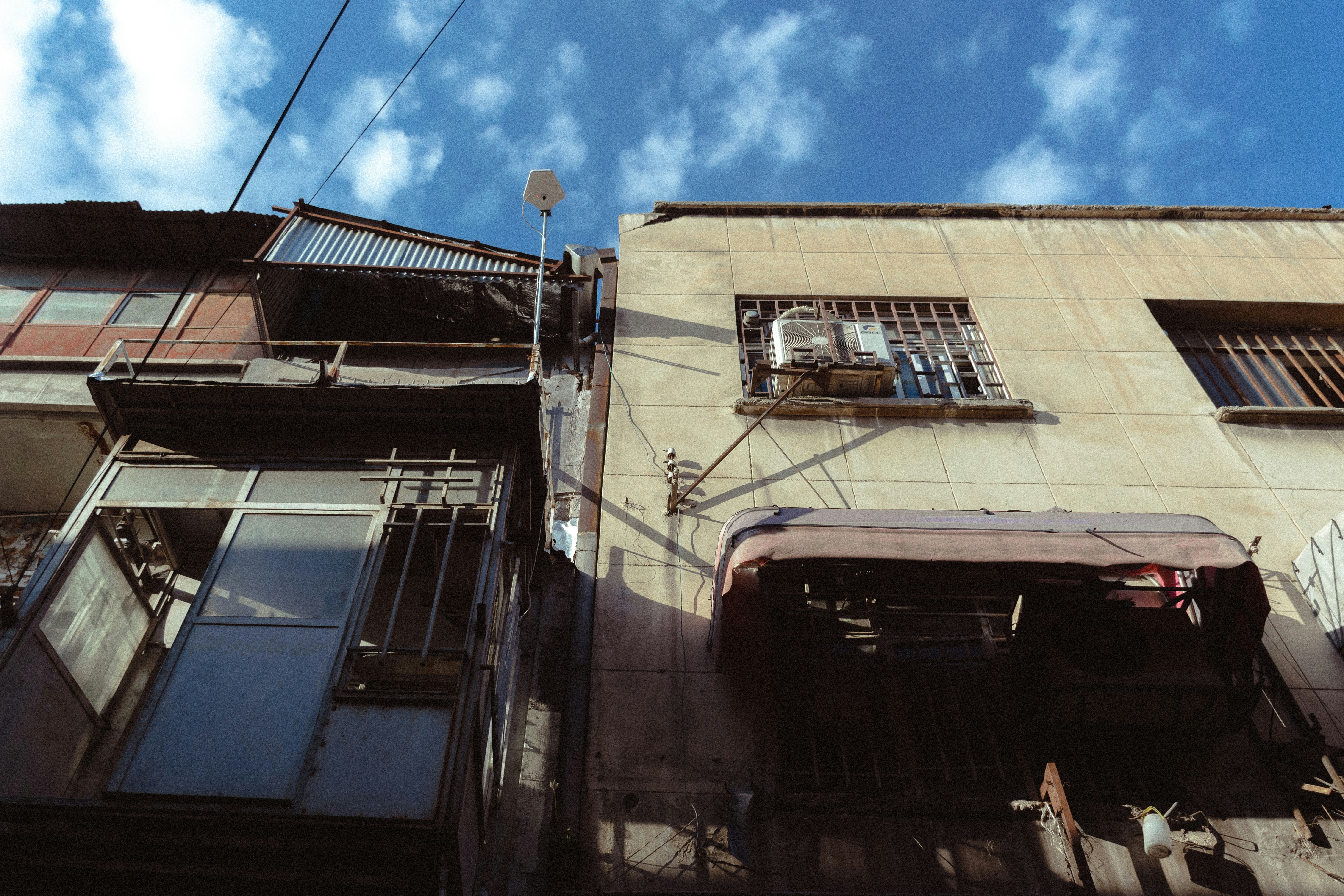 Urban Facade: A Sunlit Windowed Wall Under a Blue Sky