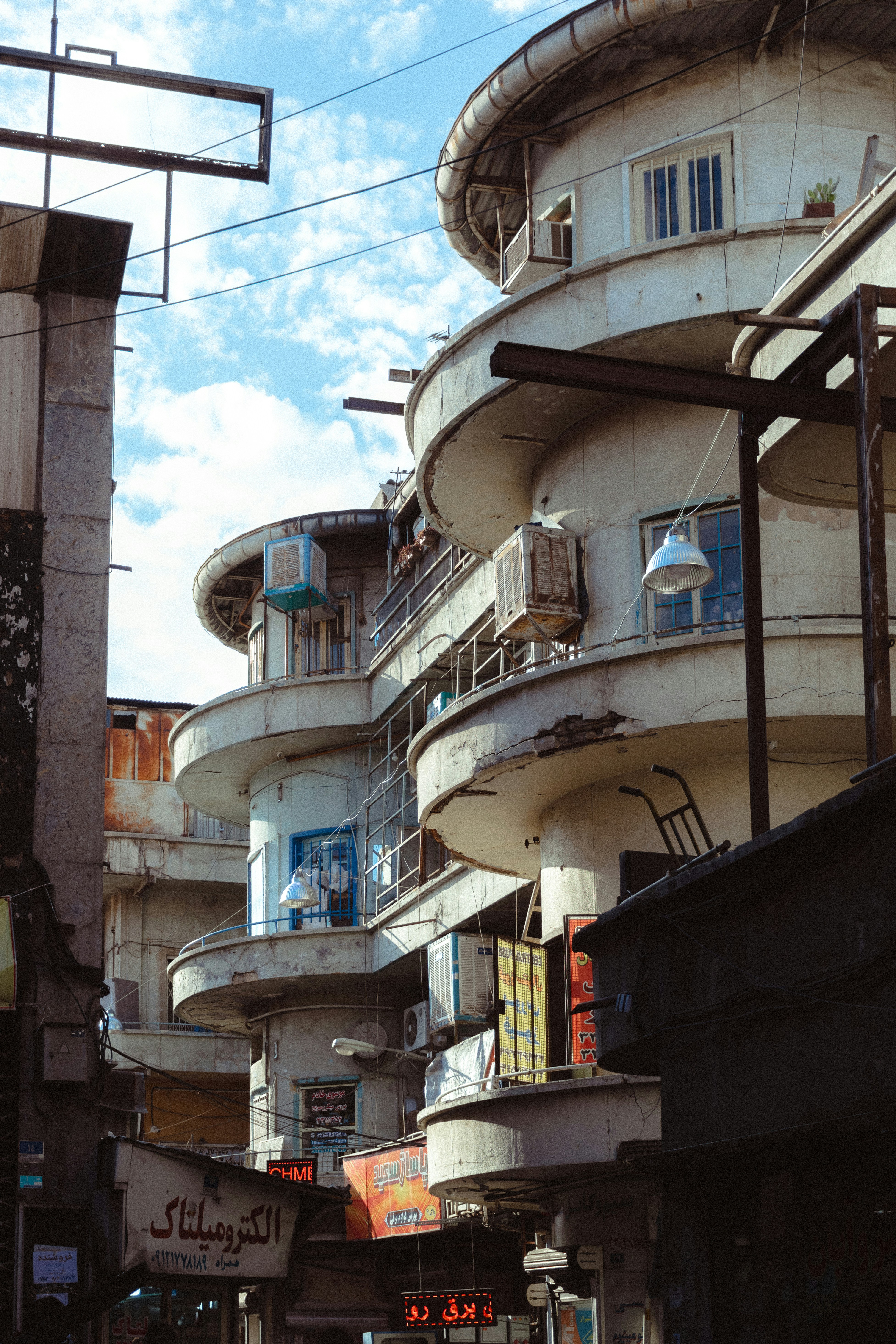 Curved Facades and Neon Signs: A Vertical Slice of a Weathered Calle