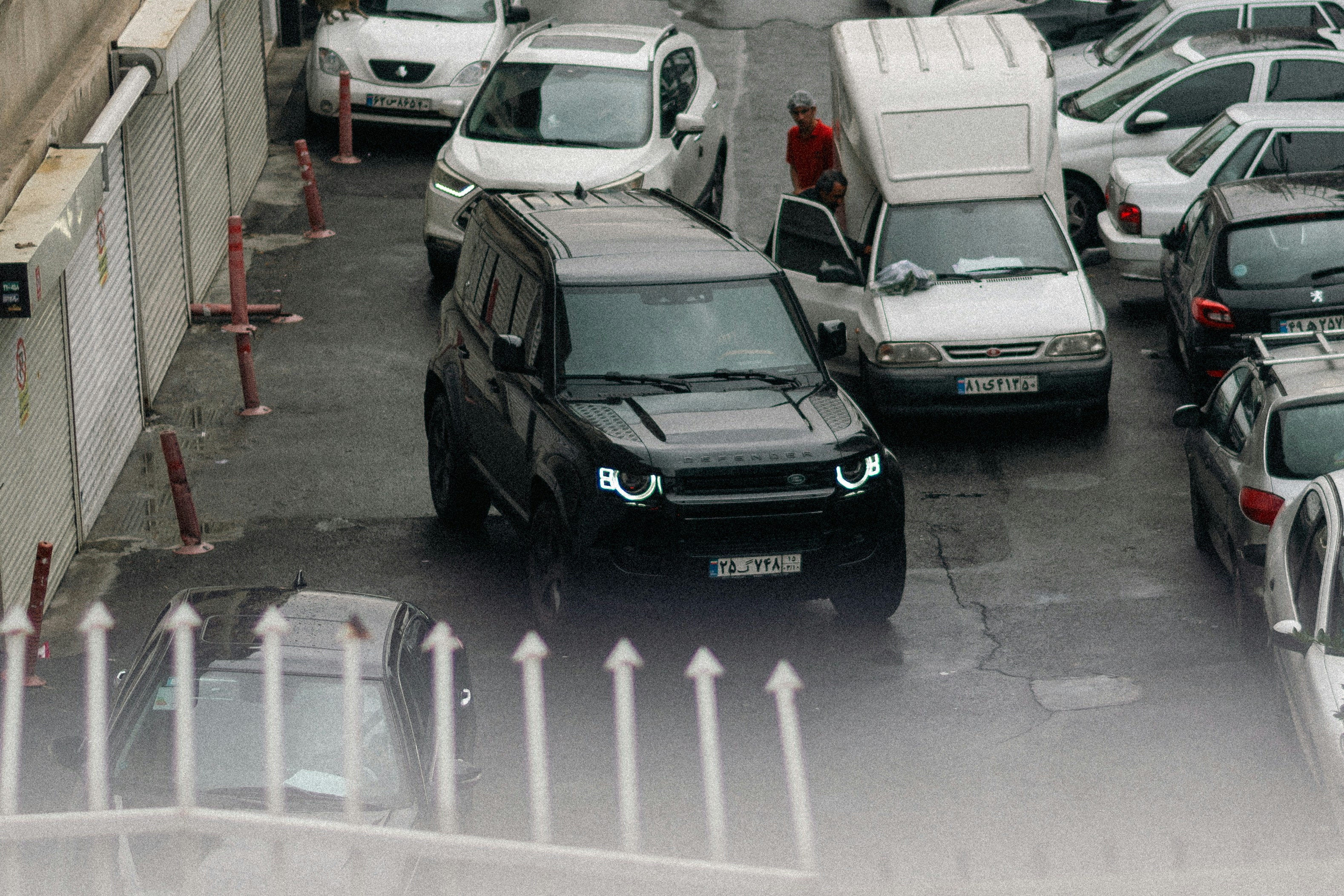Midday City Climb: A black SUV Surrounded by Light-Shifted Traffic