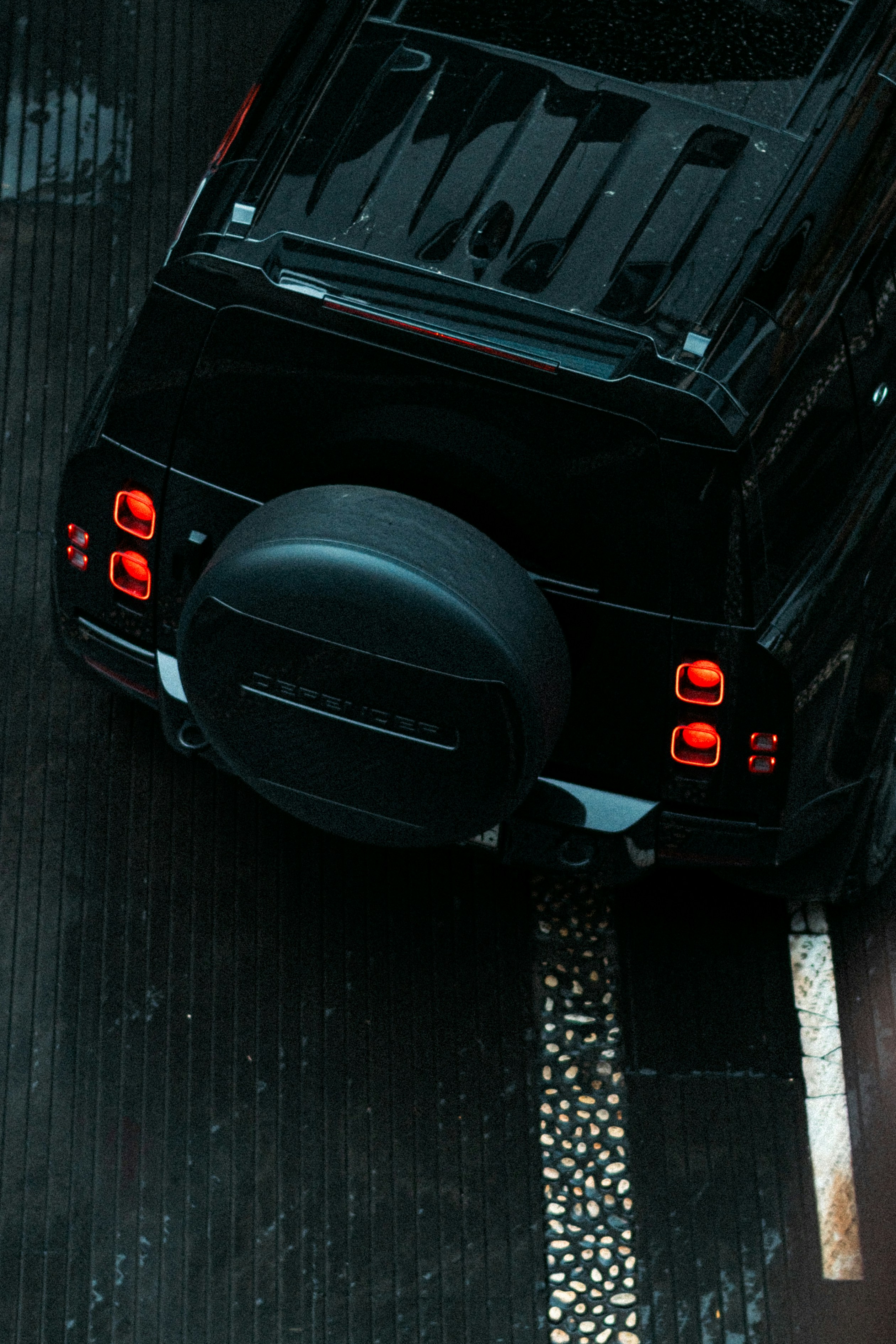 Rear View of a Dark SUV with Spares: Night City Drive