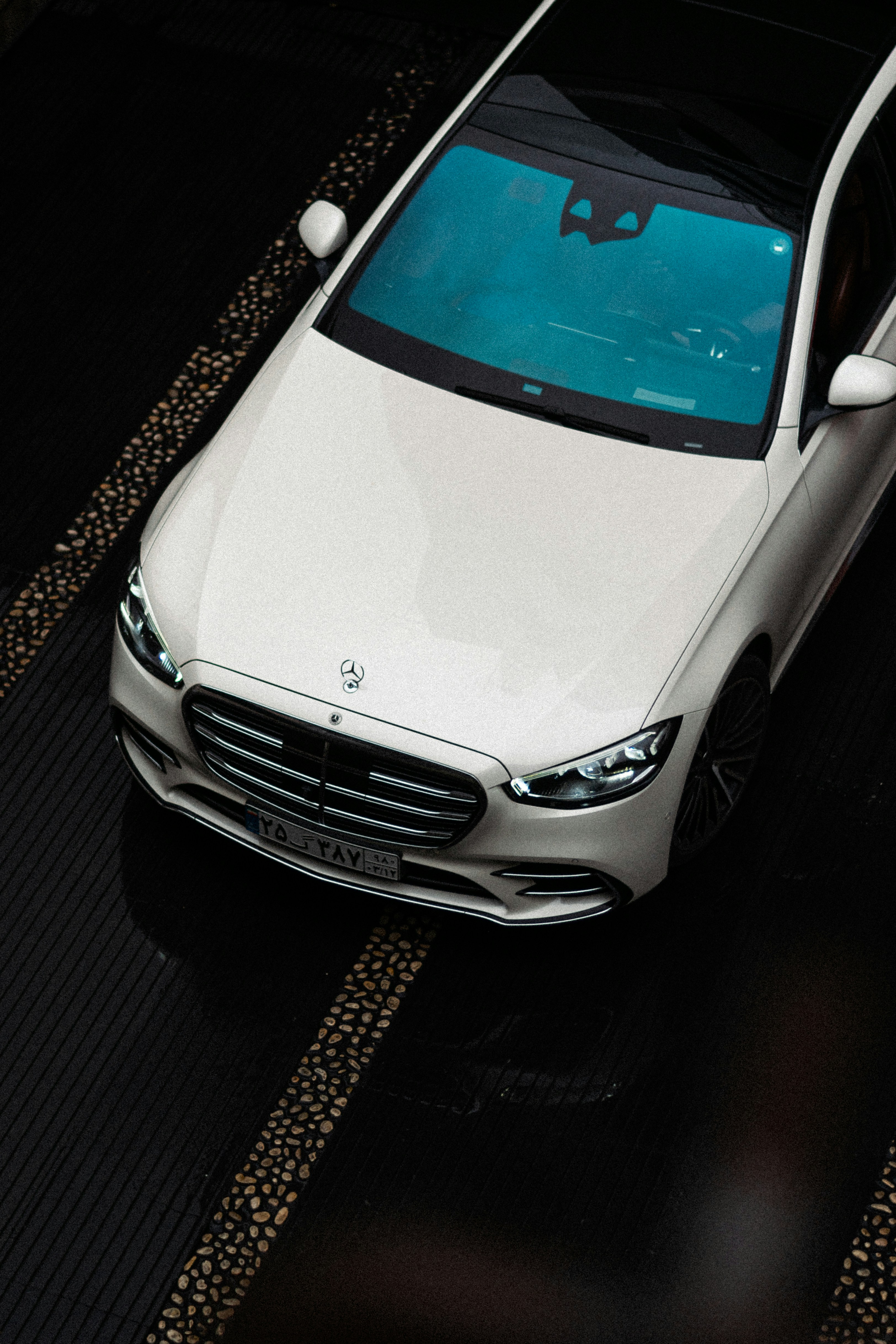 Aerial Car Portrait: Silver Mercedes Lined by Wet Track