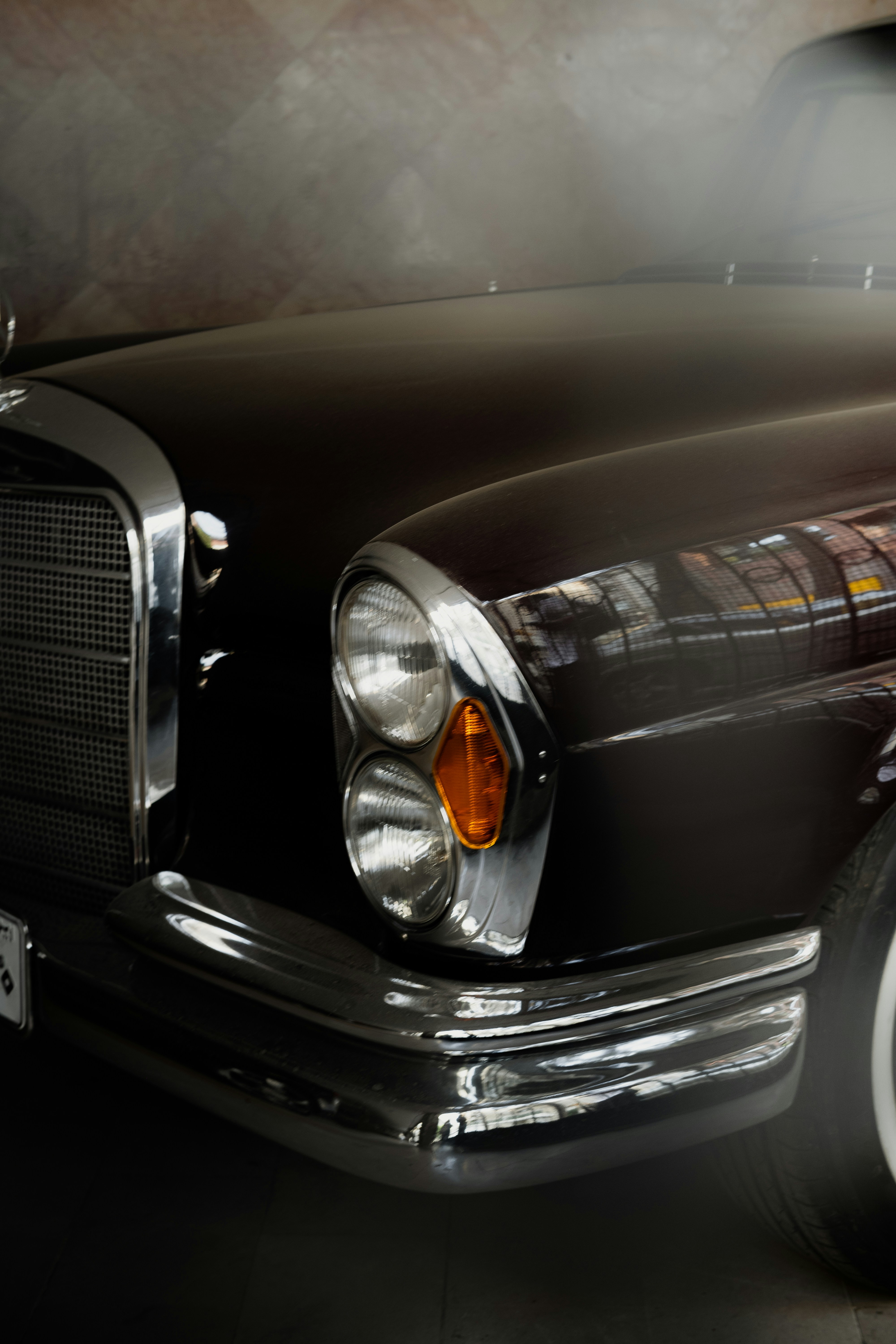 Chrome Reflections: A Classic Car Emerges from the Shadow